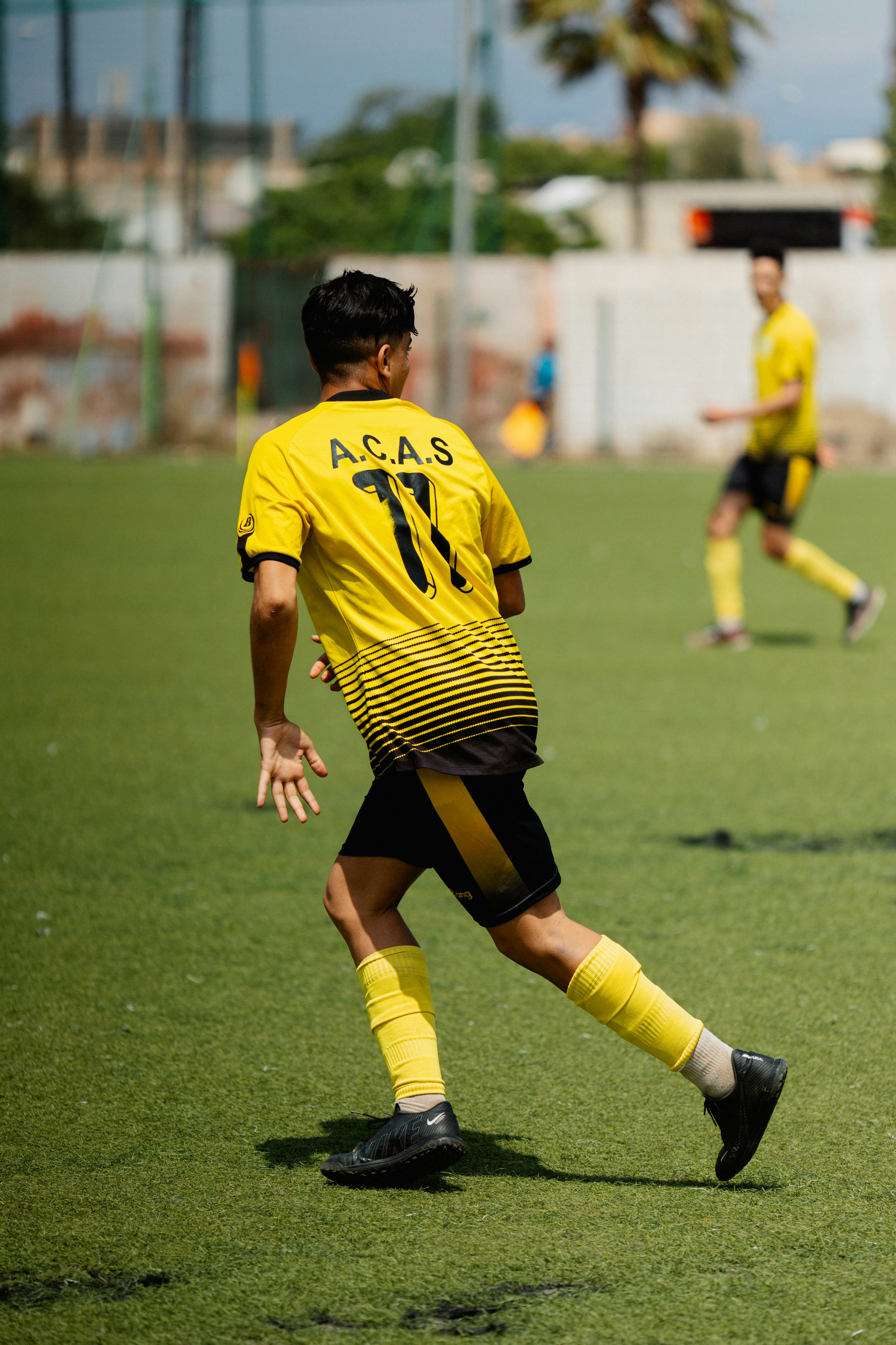 Yellow Banner in Motion: A.C.A.S. Drives Forward on a Sunlit Field