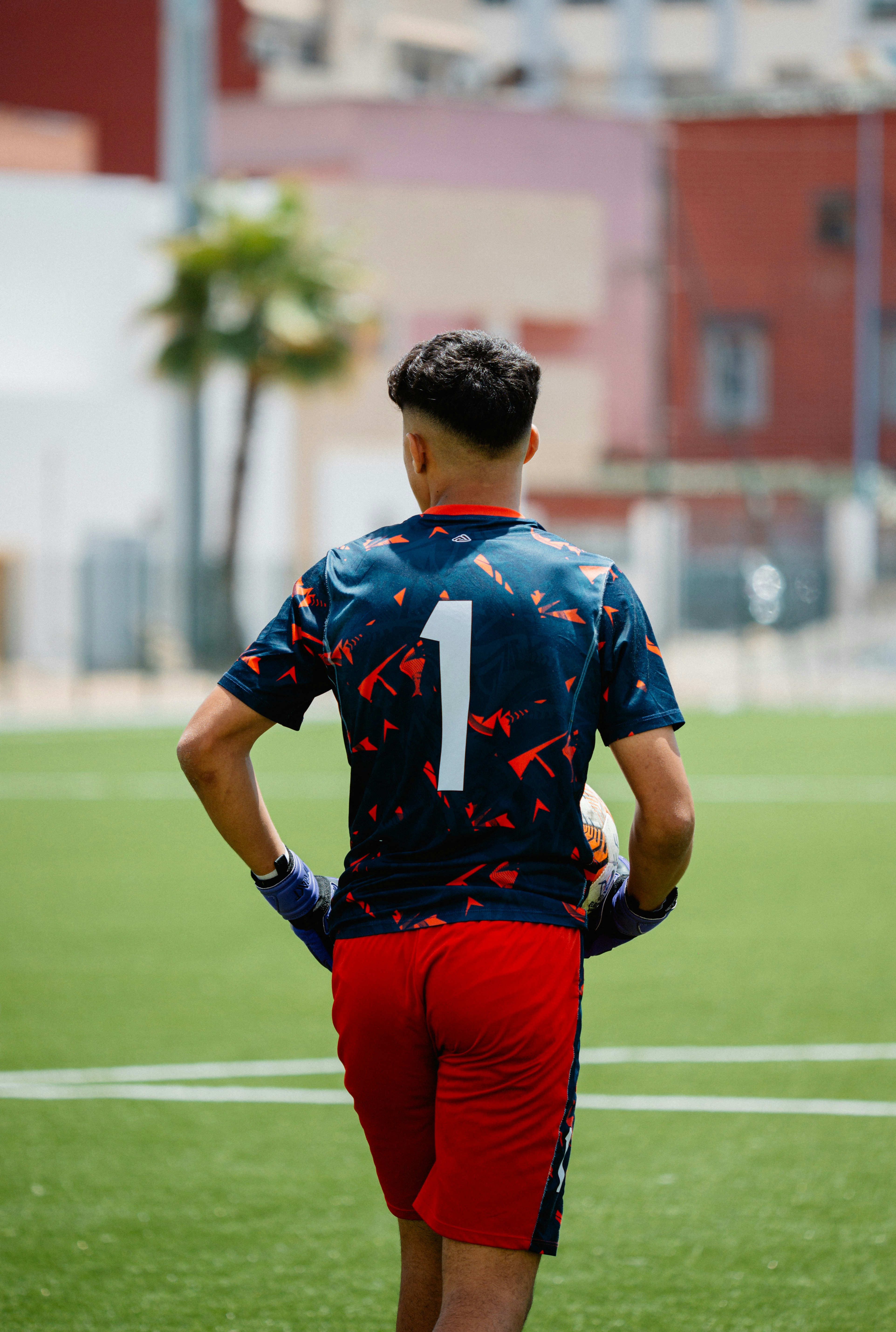 A soccer goalkeeper stands ready on the field. photo – Free Human Image ...