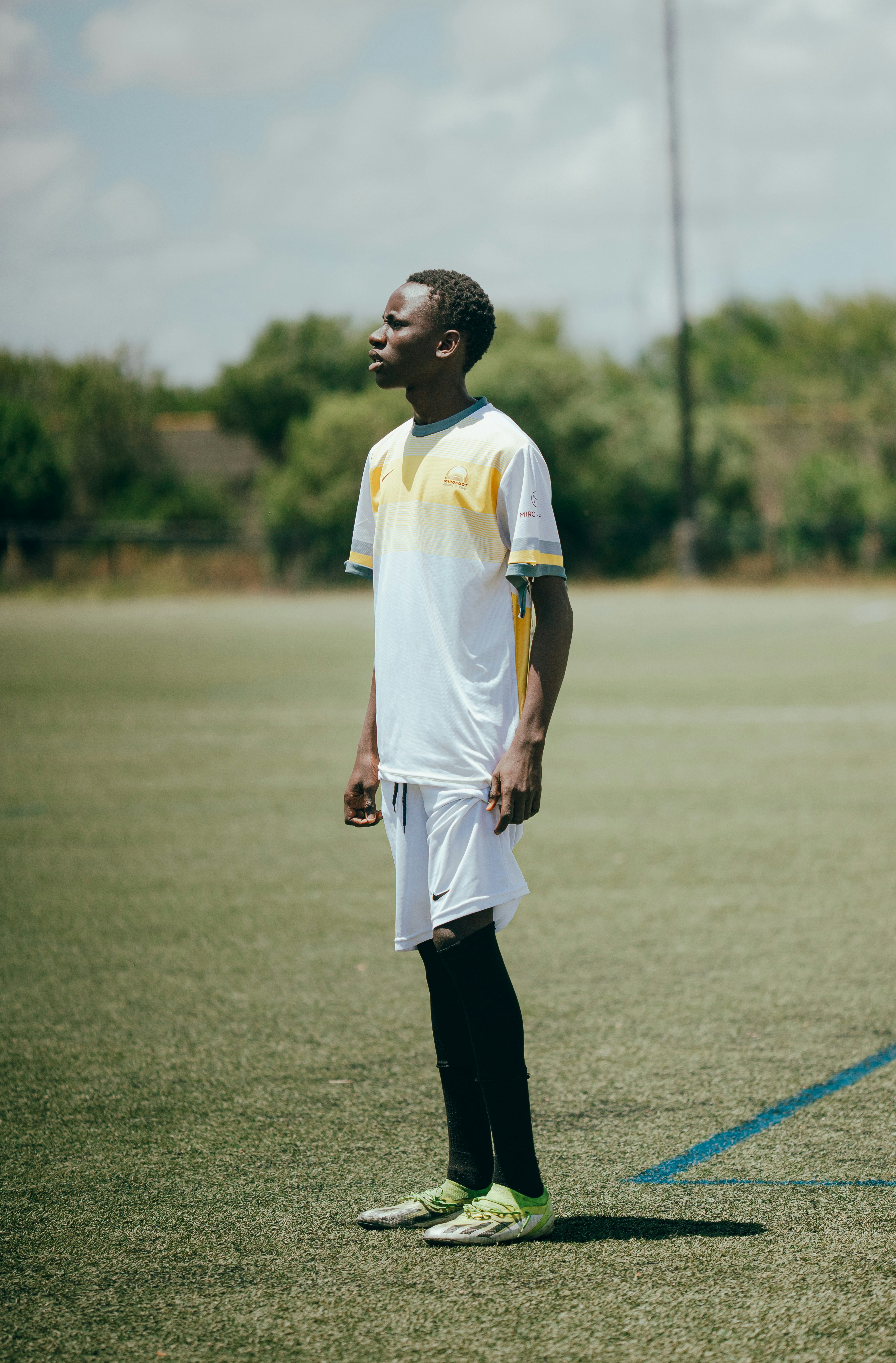 A soccer player stands on a field looking ahead. photo – Free Human ...