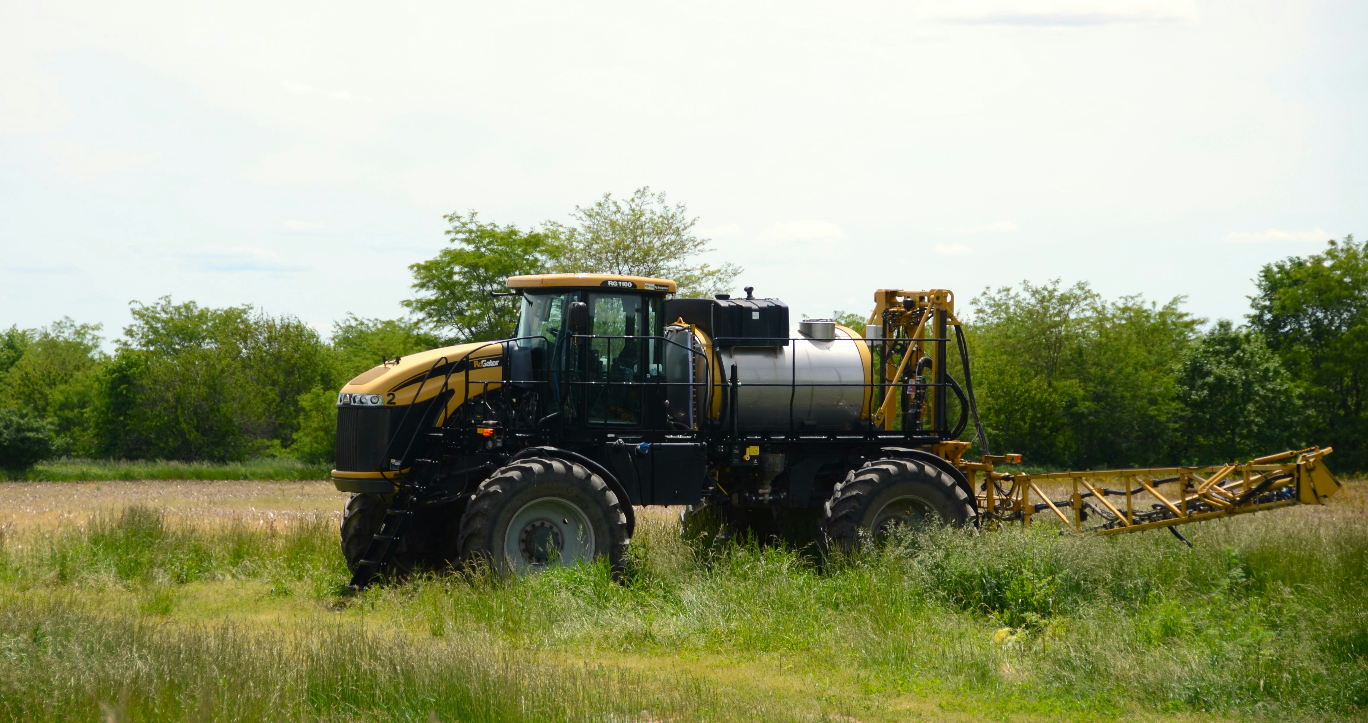 Prairie Sentinel: A Modern Sprayer Anchored in an Open Field