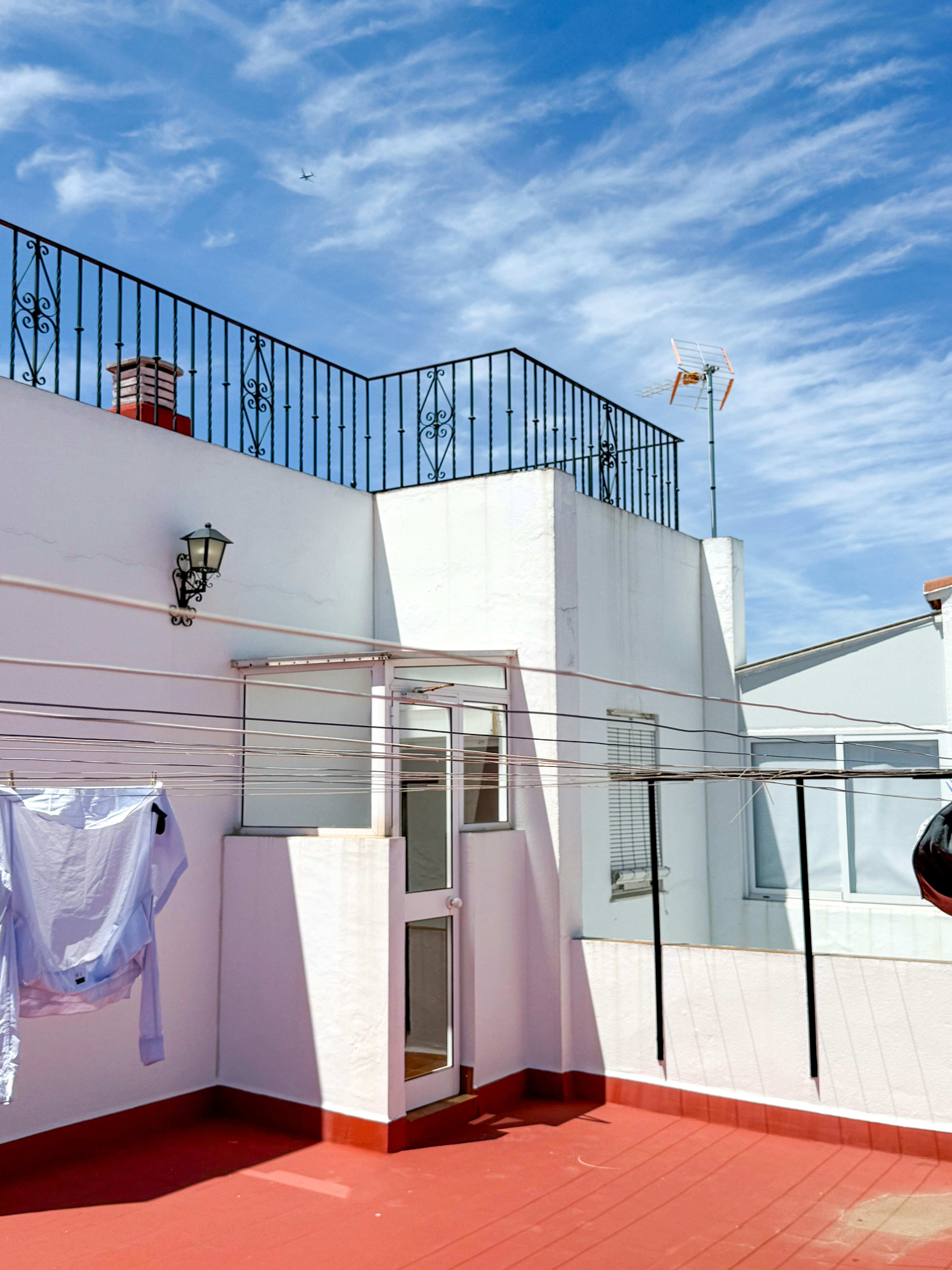 Terrace Lines and Sky: Rooftop Context on a Bright Day