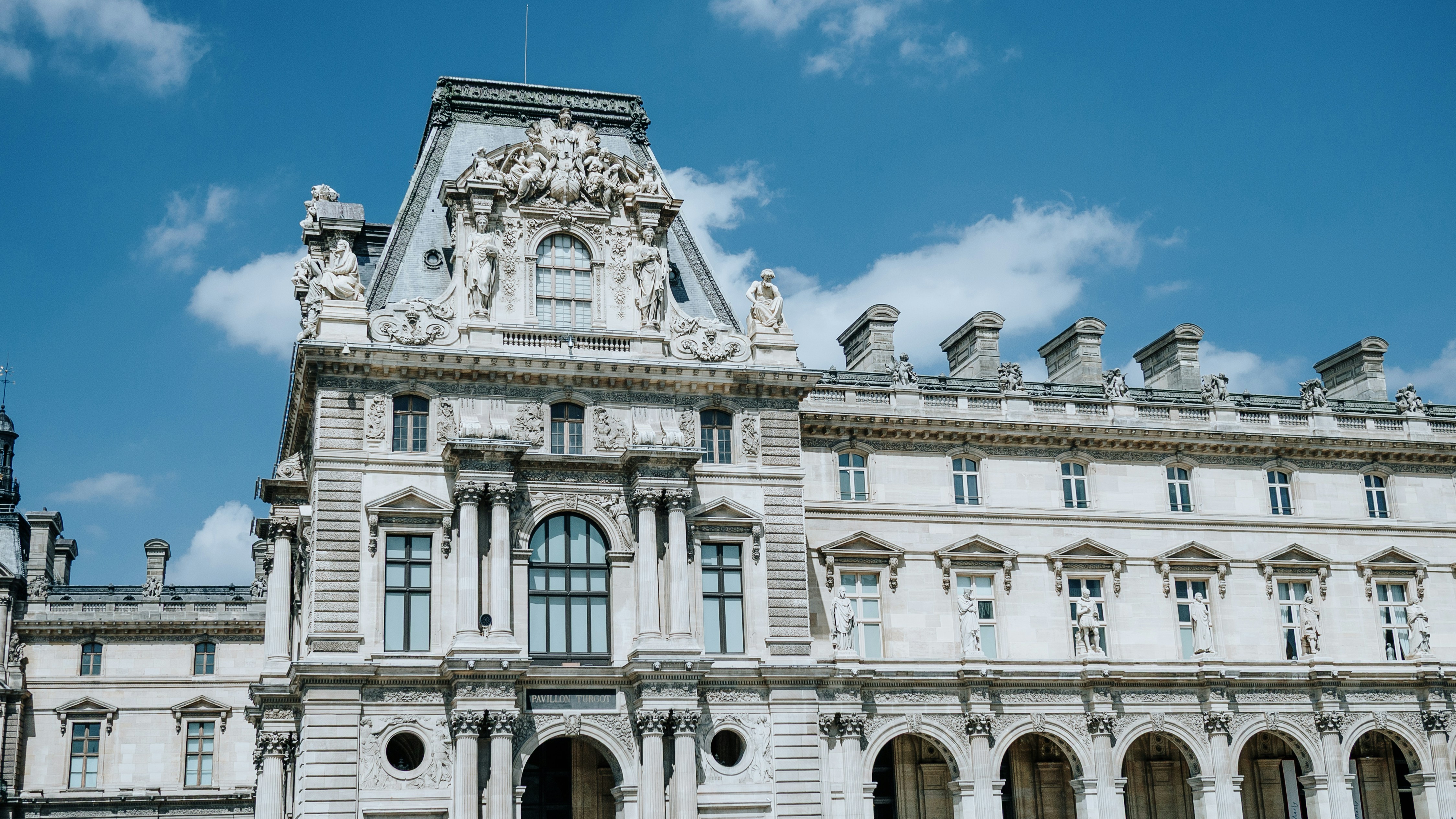 The louvre museum's exterior, bathed in sunlight. photo – Free Paris ...