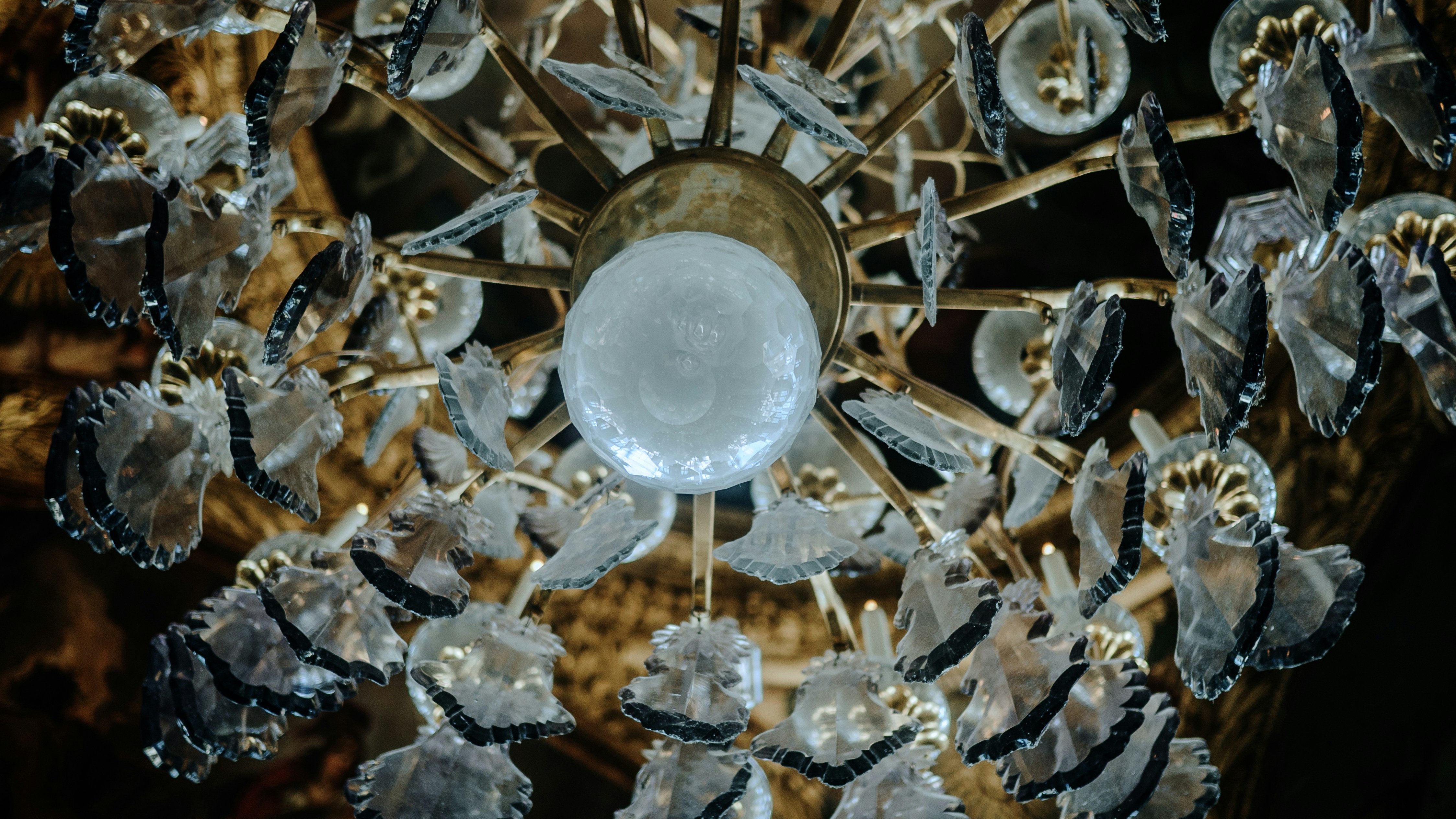 Heart of Crystal: Frosted Globe Anchoring a Starburst Chandelier