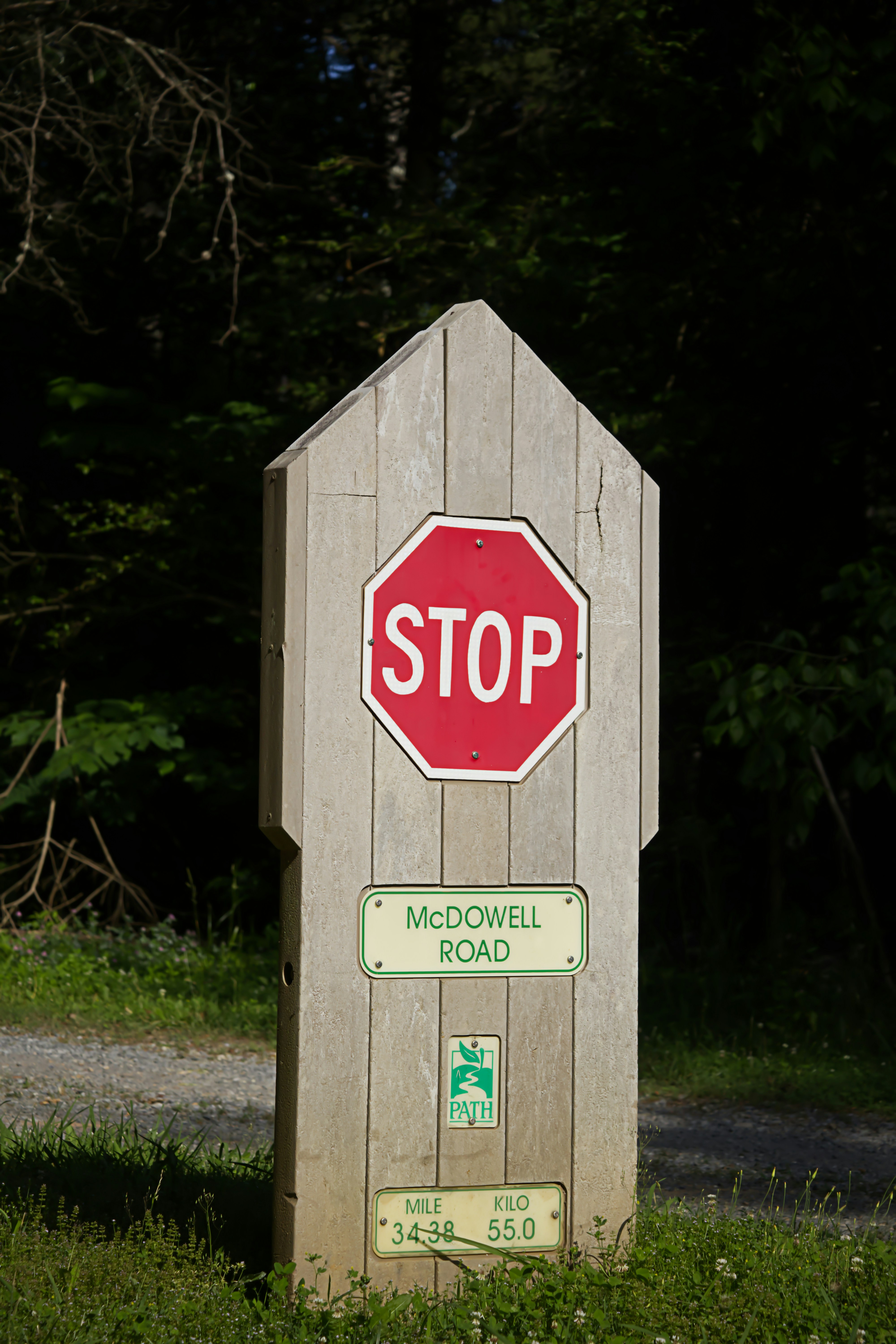 Crimson Stop Sign on a Weathered Timber Pillar Beside McDowell Road