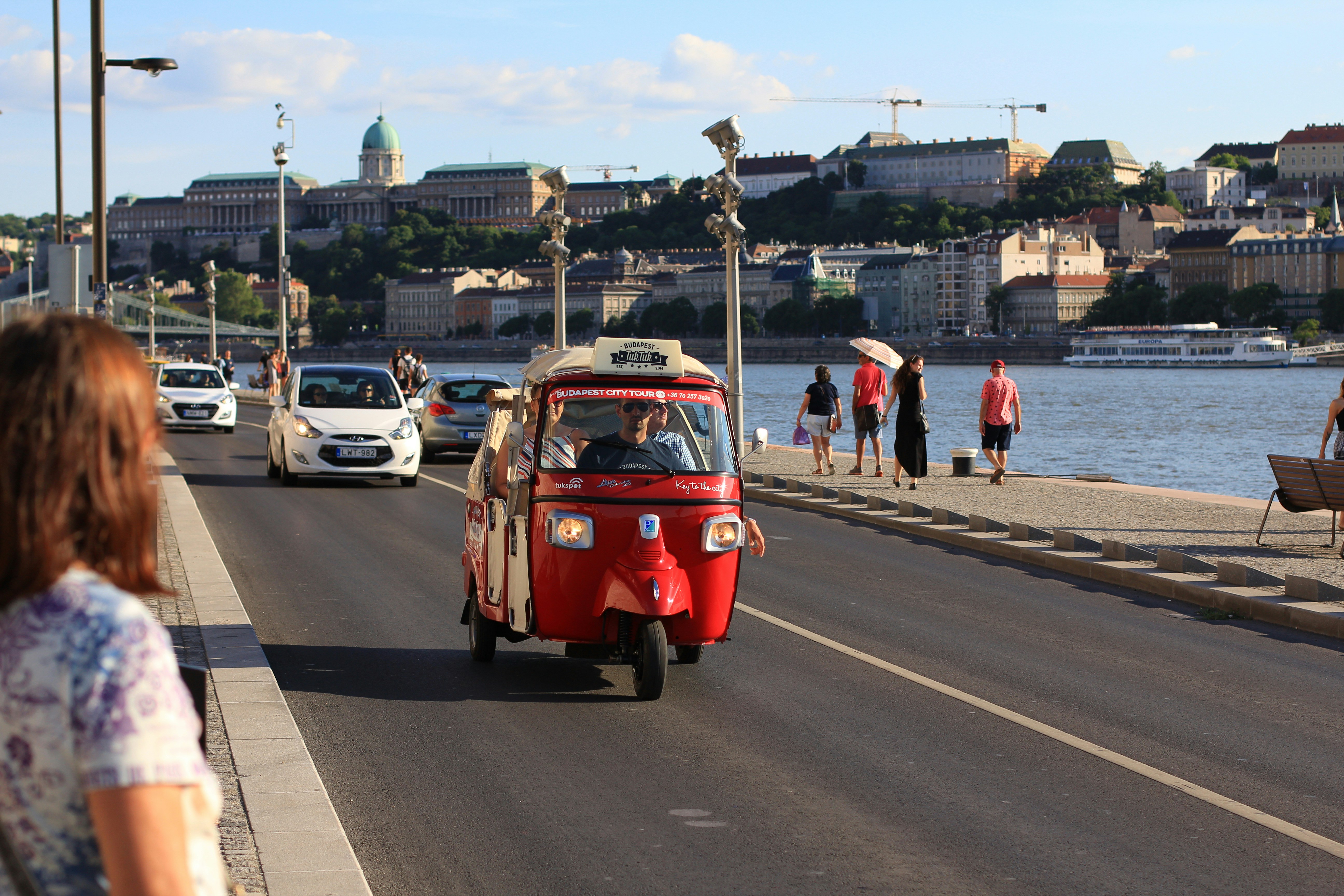 Crimson Tuk-Tuk on the Danube Boulevard: Cityscape in Motion