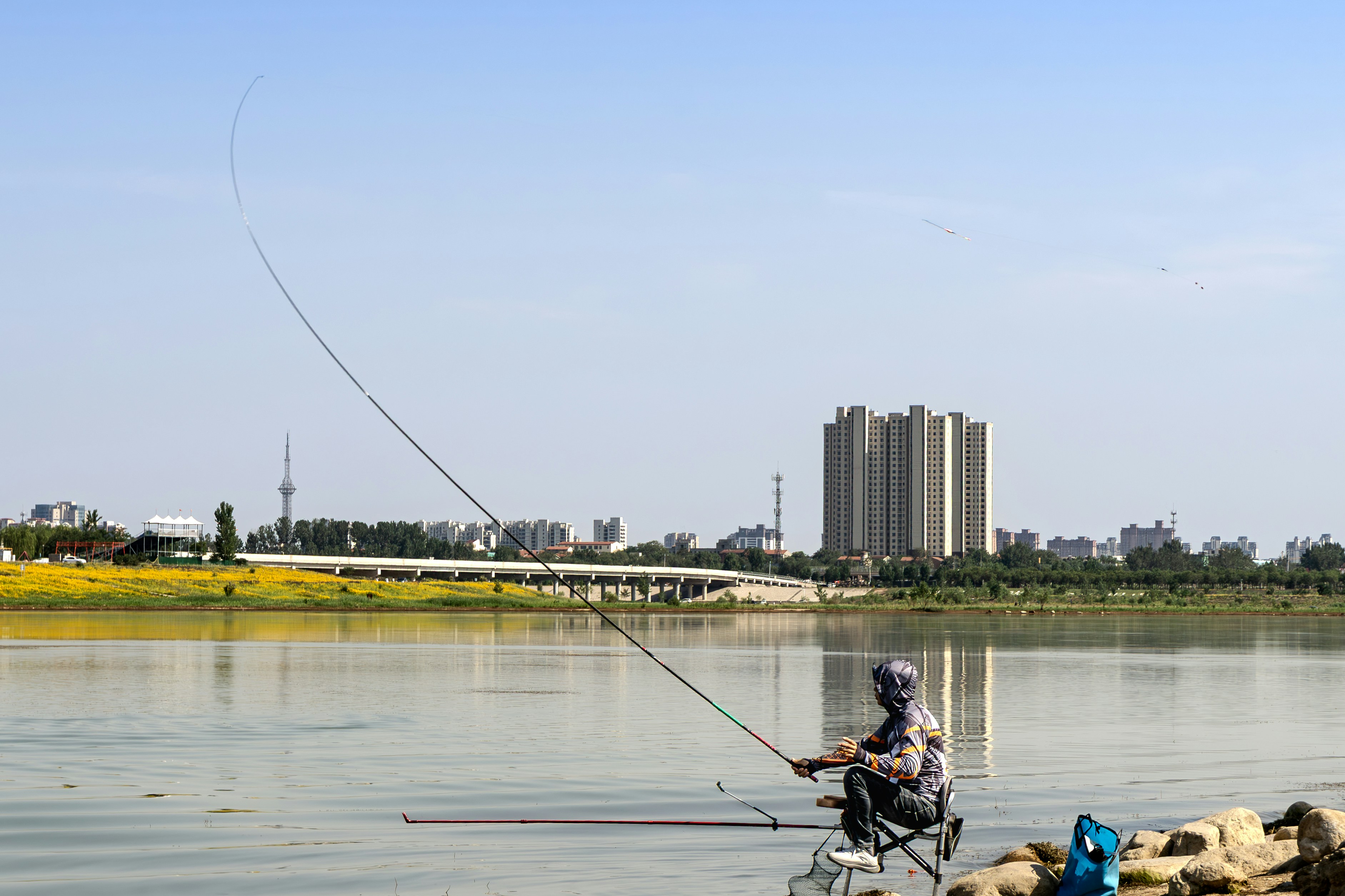 A quiet afternoon moment captured during the perfect cast. I waited for his second swing, shooting in burst mode to catch the arc of the rod and the gesture of his balancing hand.
