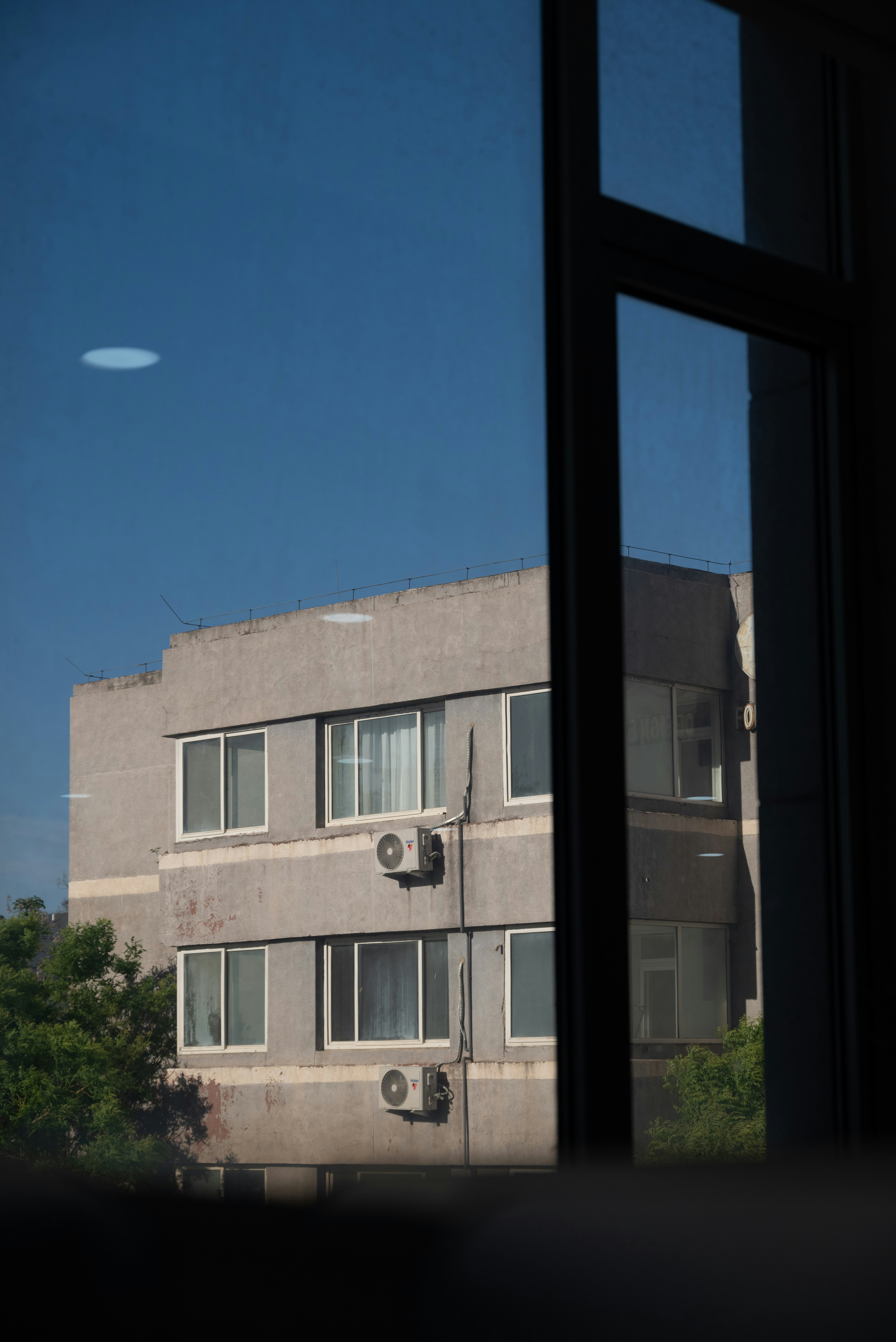 Glass, Concrete, and Quiet Light: A Windowed View of a City Block