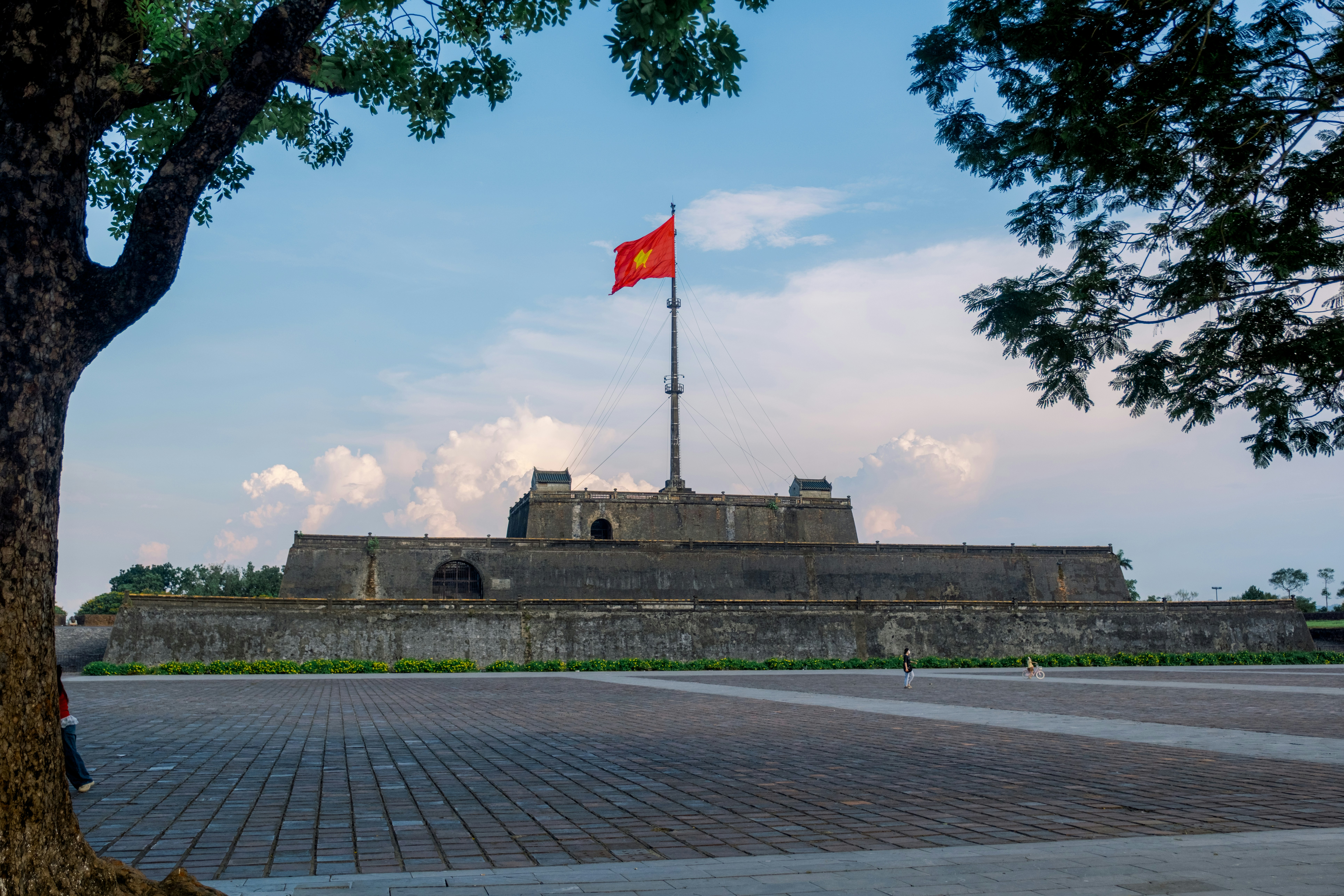Flag over Quiet Bastion: A Vietnamese Fortress Under Blue Skies