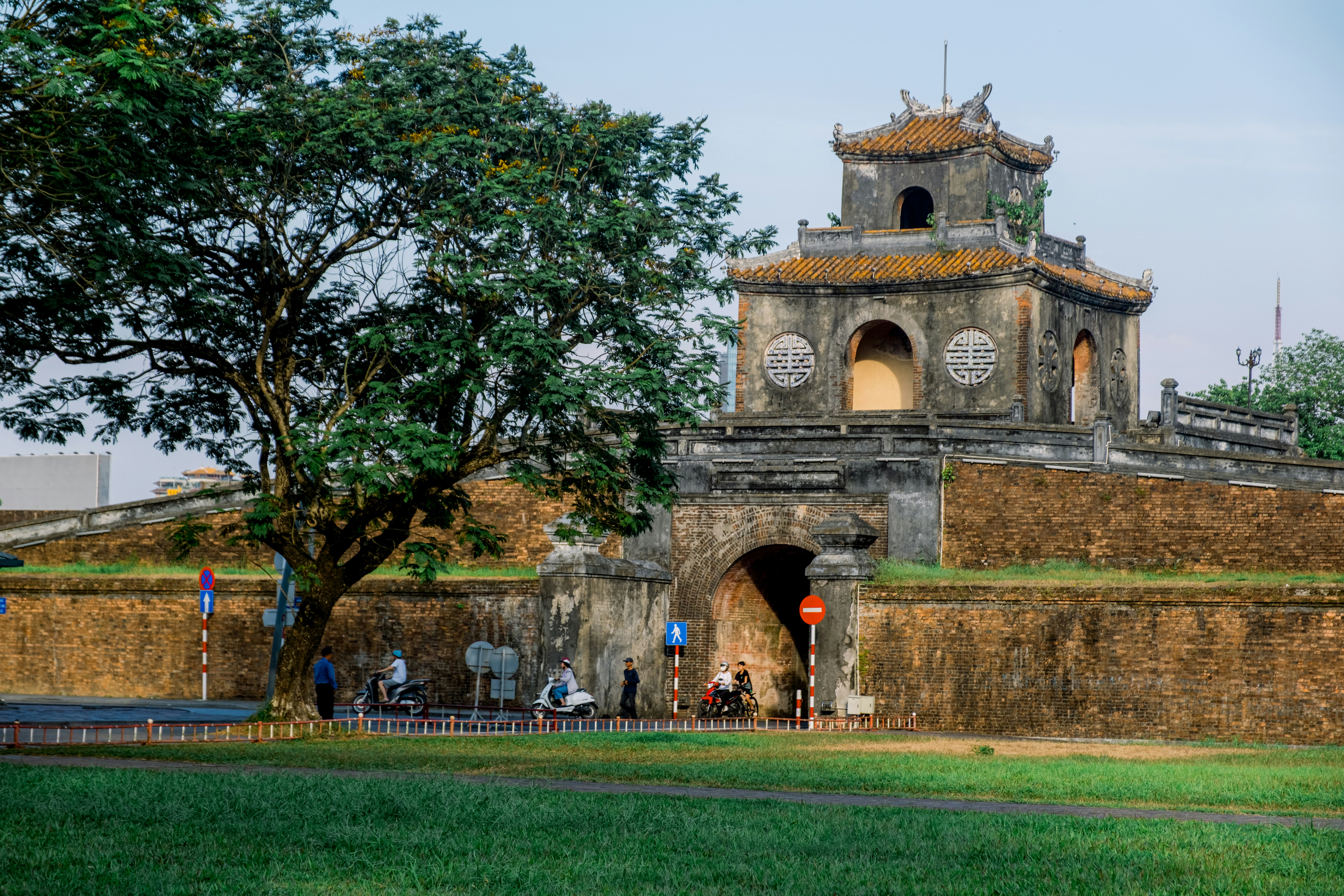 Ancient gate and wall, with a tree in foreground.