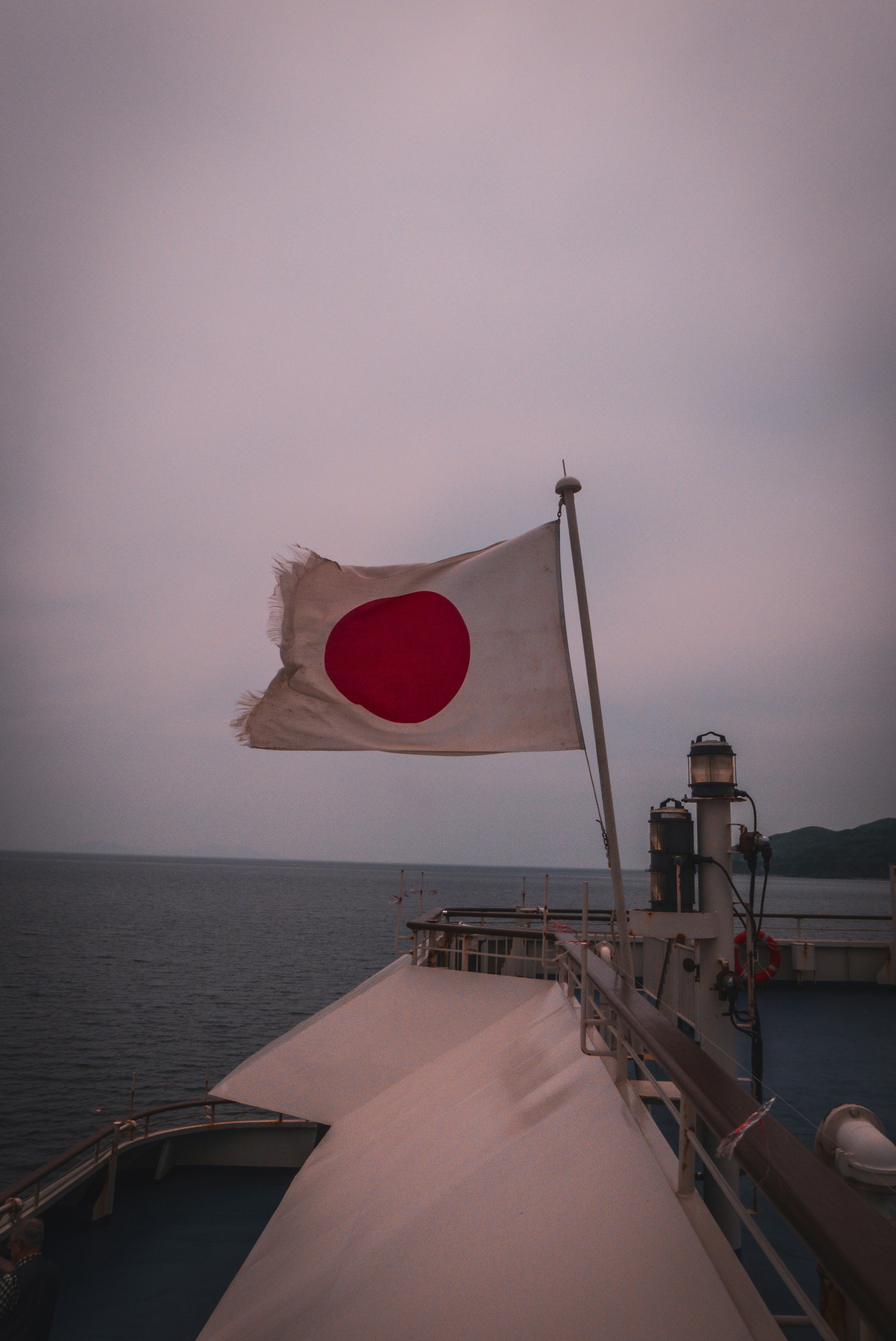 Japanese flag flies on a ship.