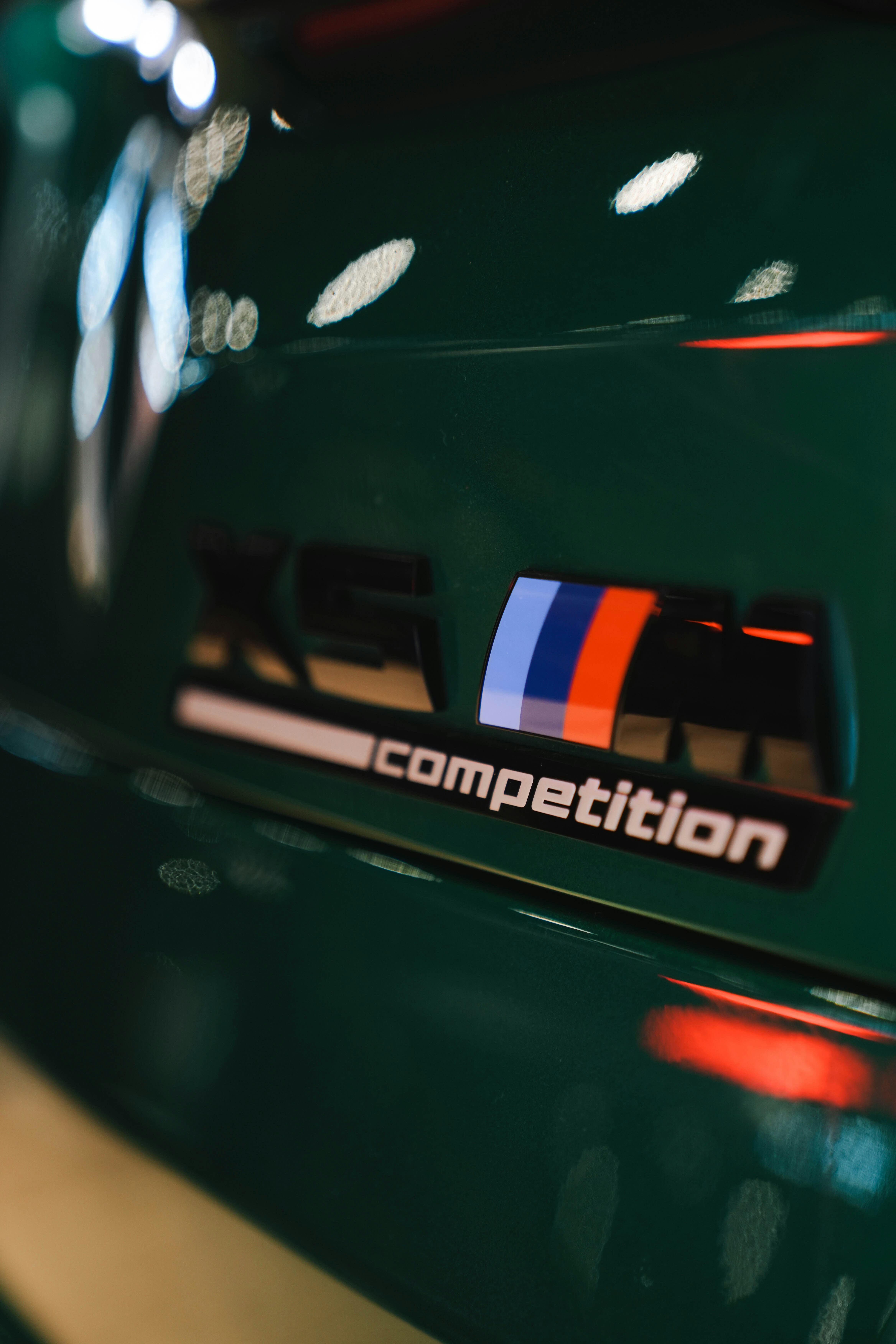 BMW x5 competition badge on a green car. photo – Free Logo Image on ...