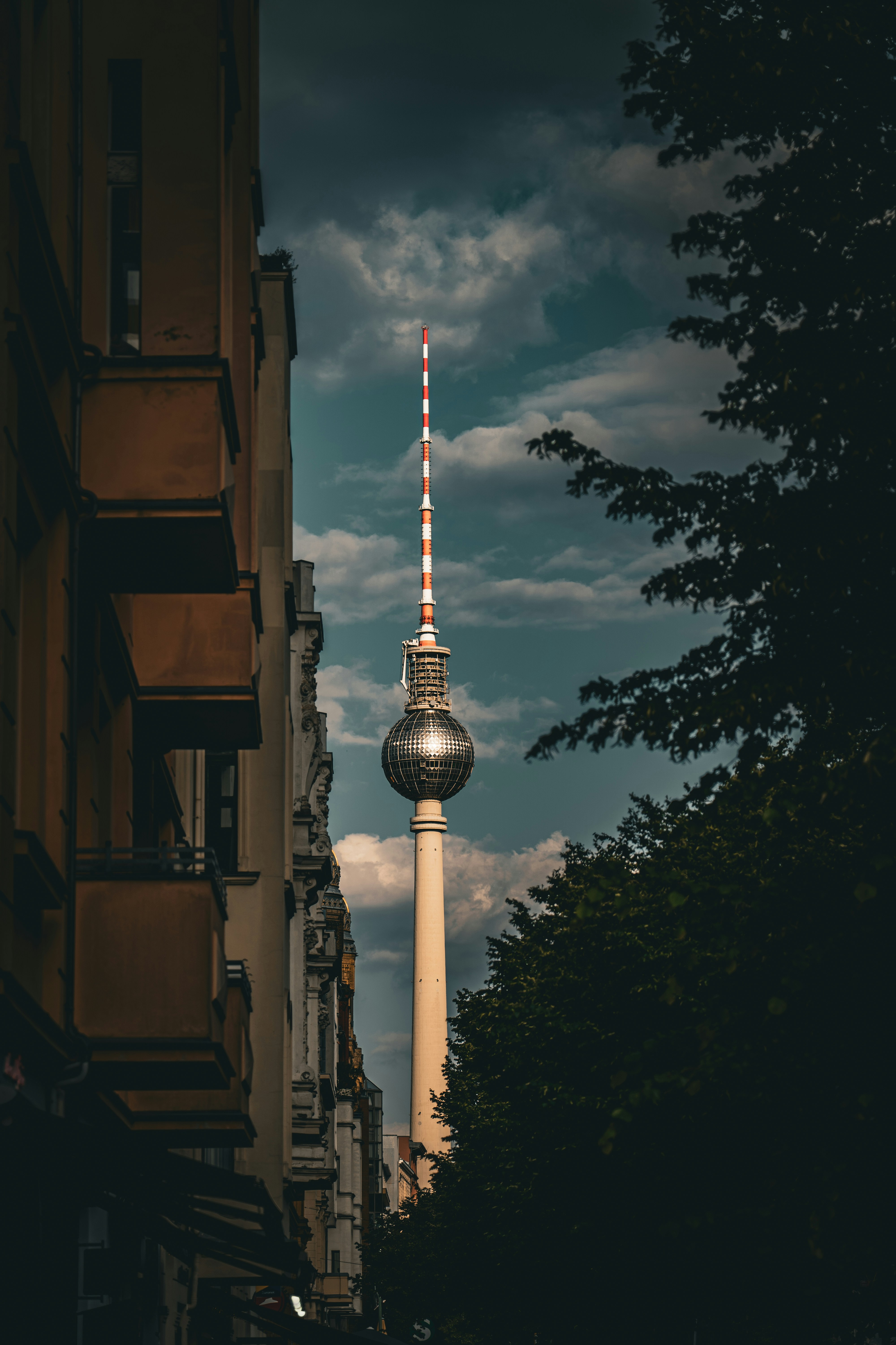 Towering Sphere: Berlin's Icon Piercing the Sky Amid Urban Canopy