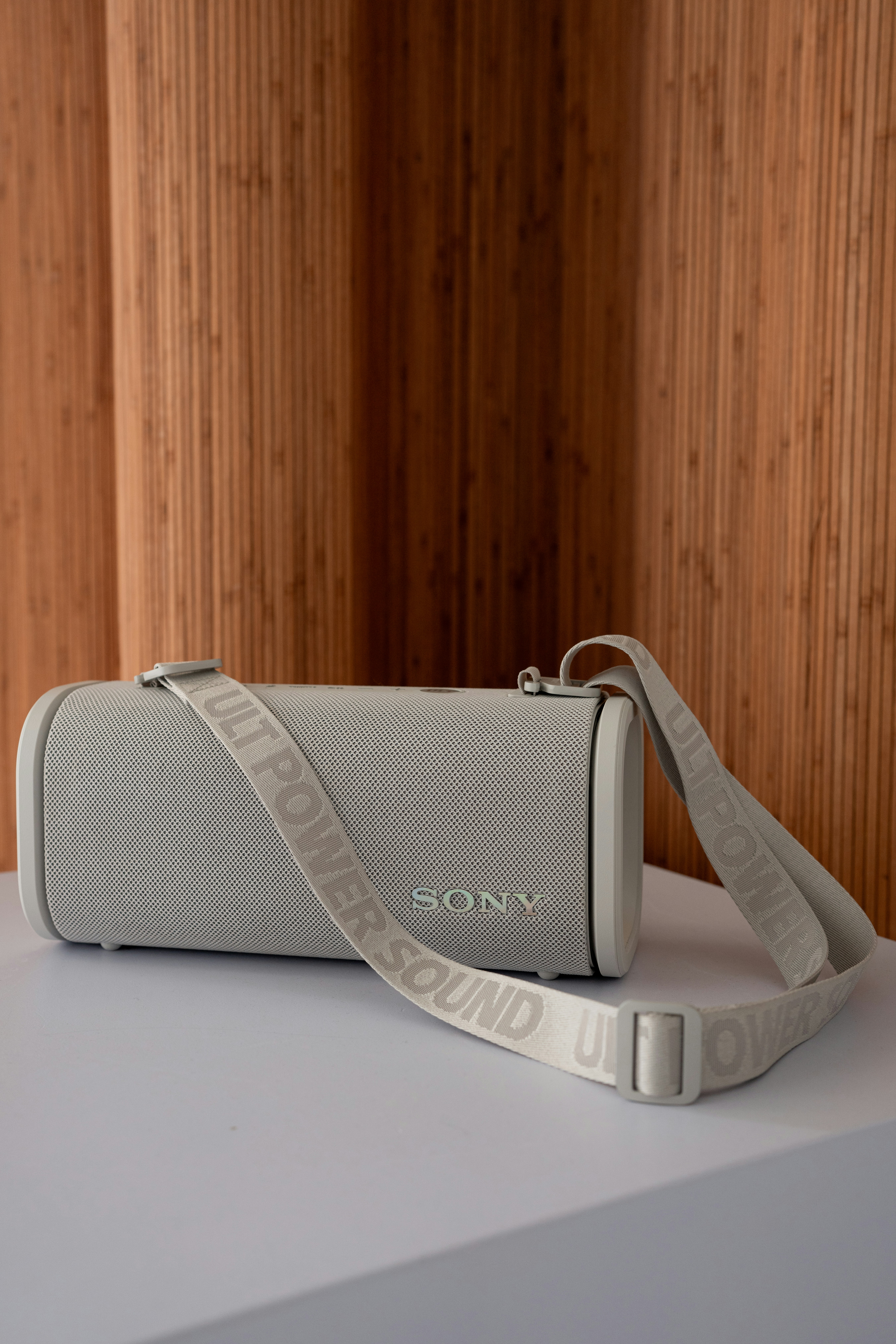 Sony ULT Field 5 Wireless Bluetooth Speaker | A gray sony speaker with shoulder strap.