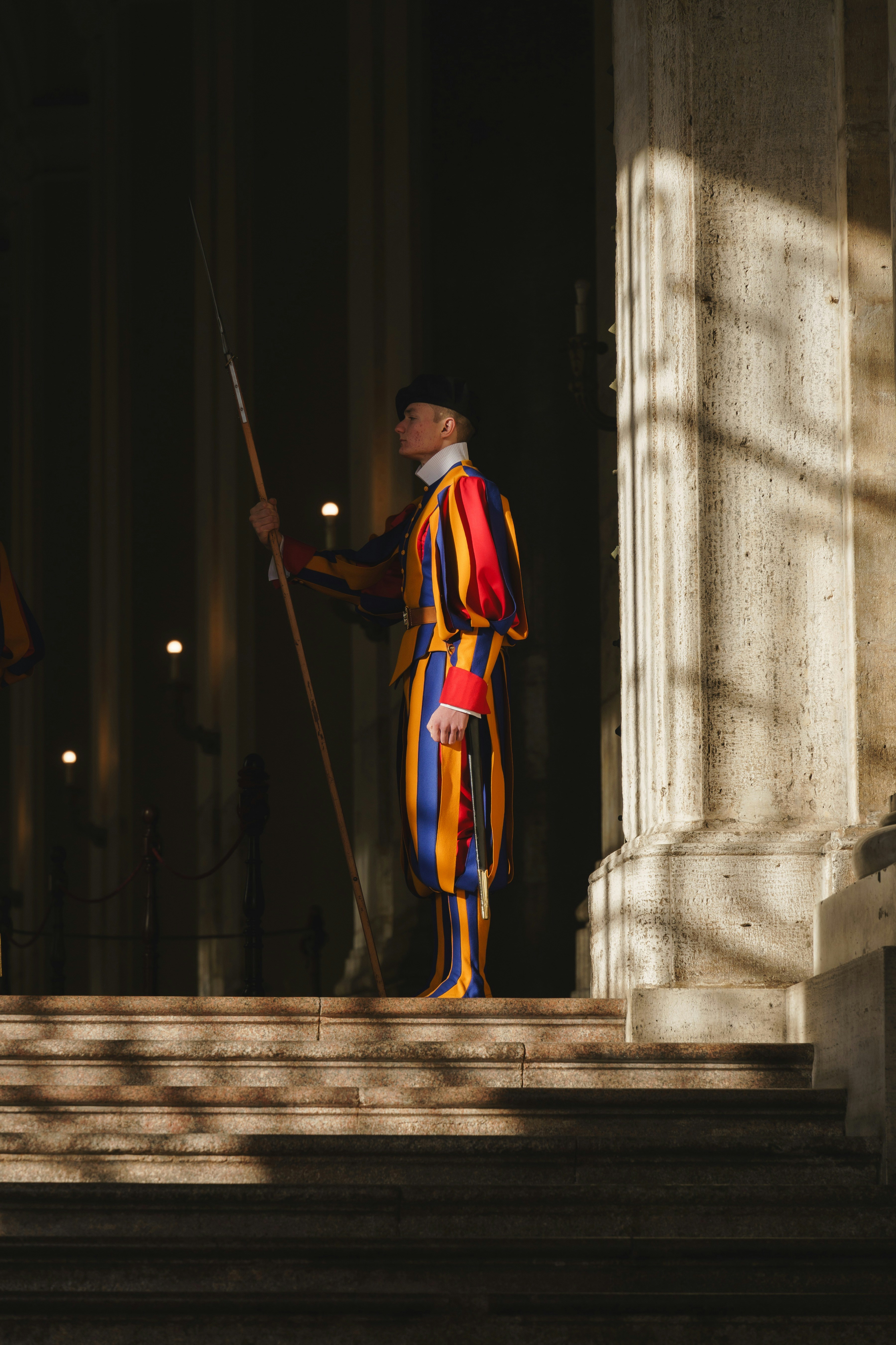 Striped Sentinel Under Lantern Light on Marble Steps