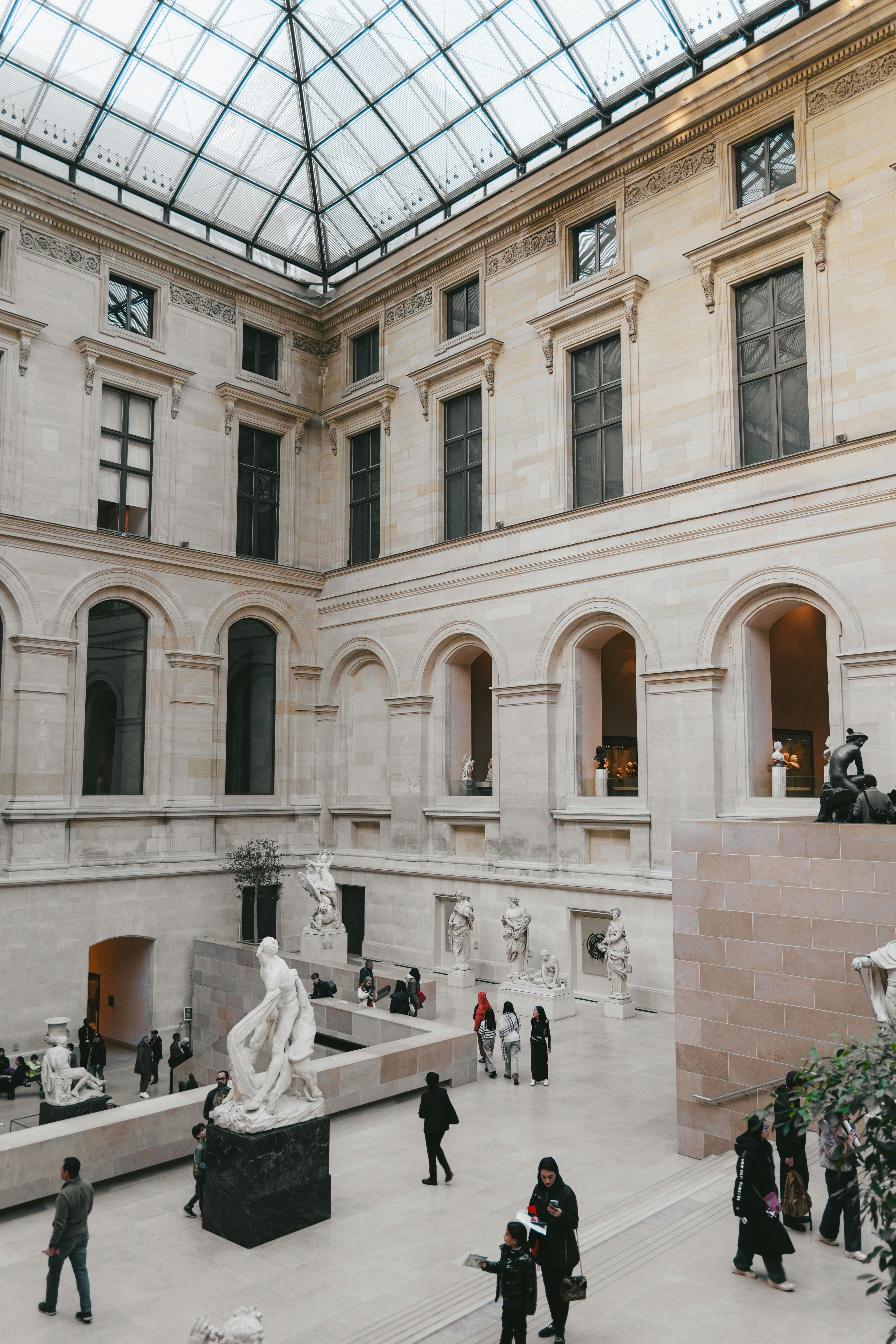 A grand museum interior with sculptures and windows. photo – Free ...