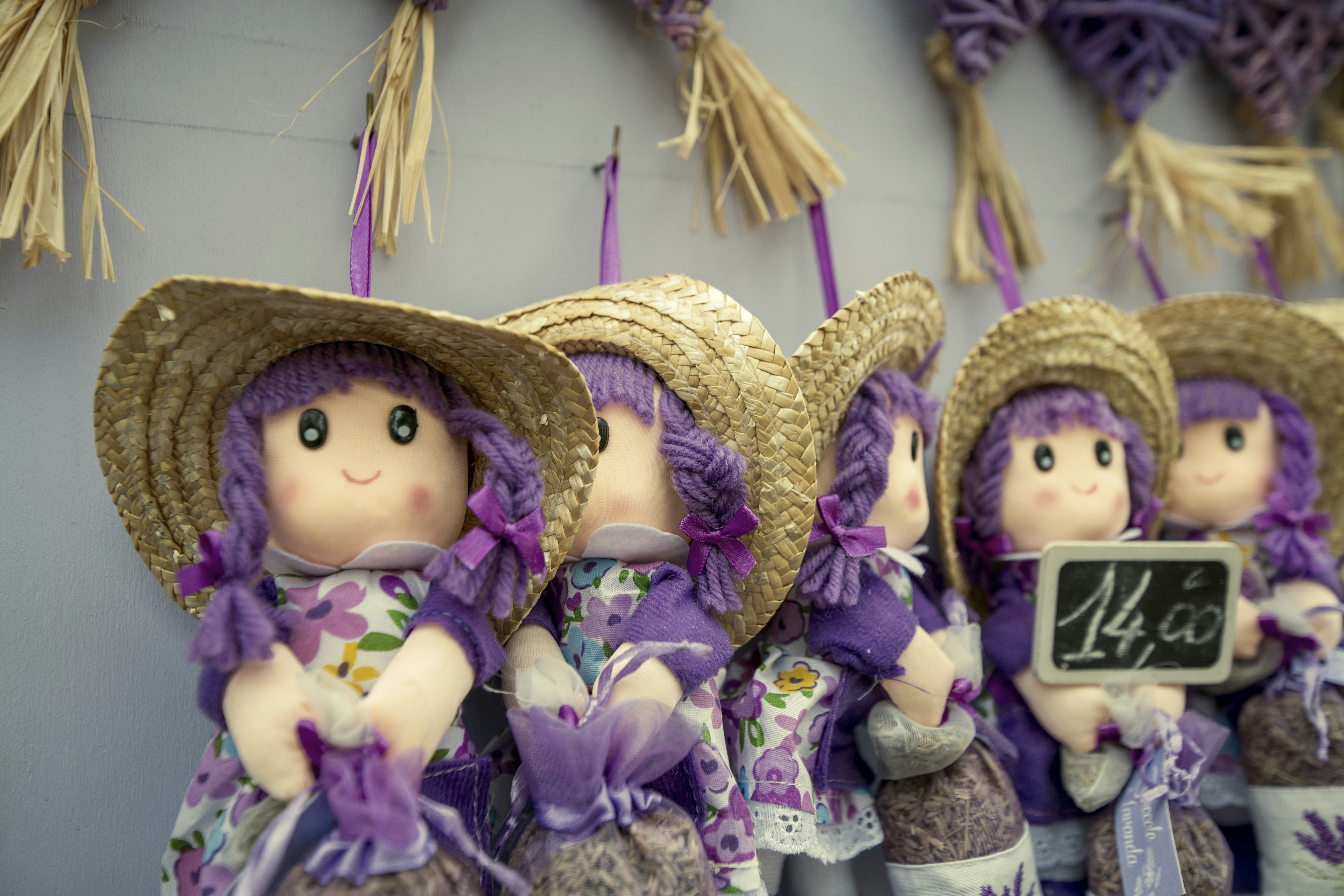 Gazebo of Purple-Straw Hats: A Row of Plush Dressed Dolls