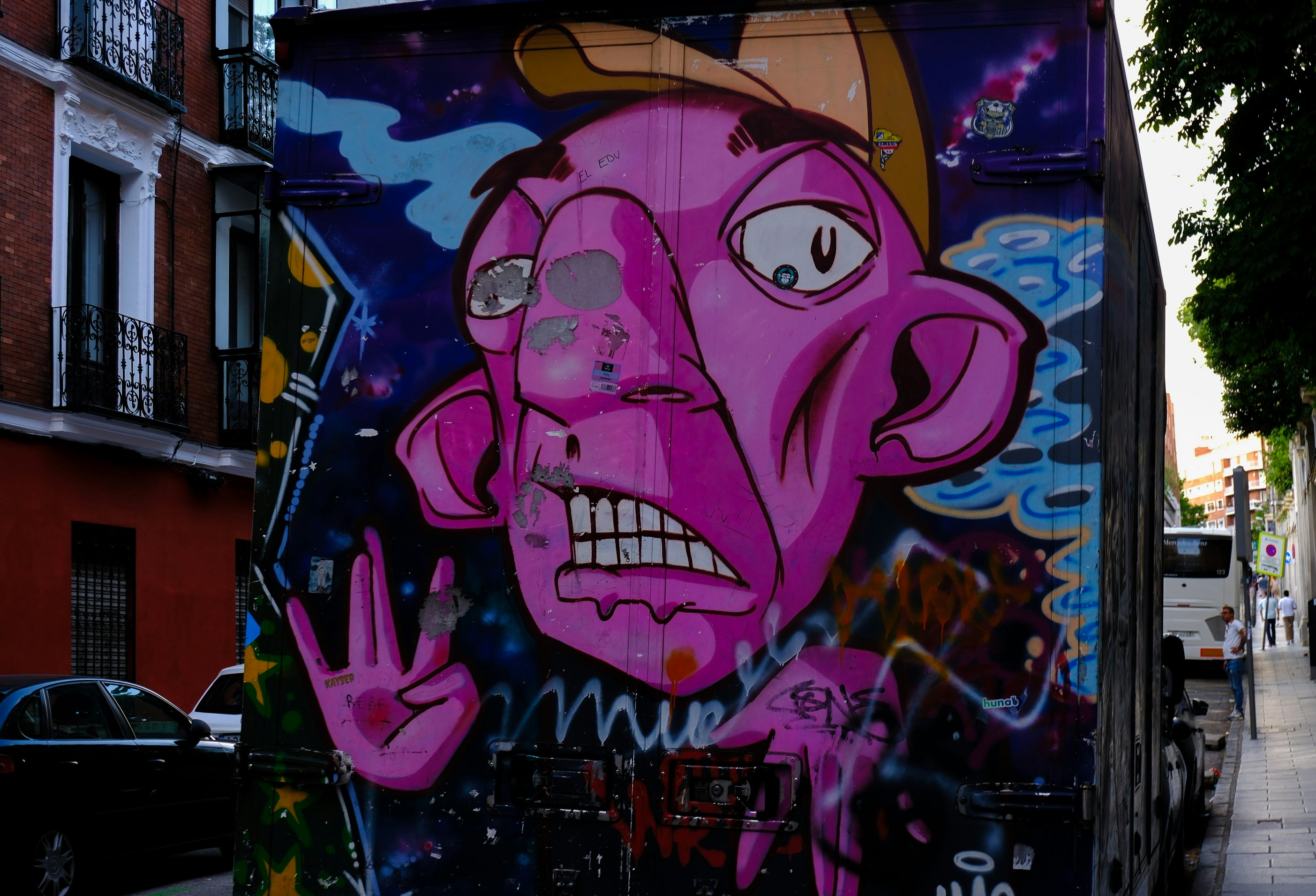 A colorful graffiti mural decorates a truck.