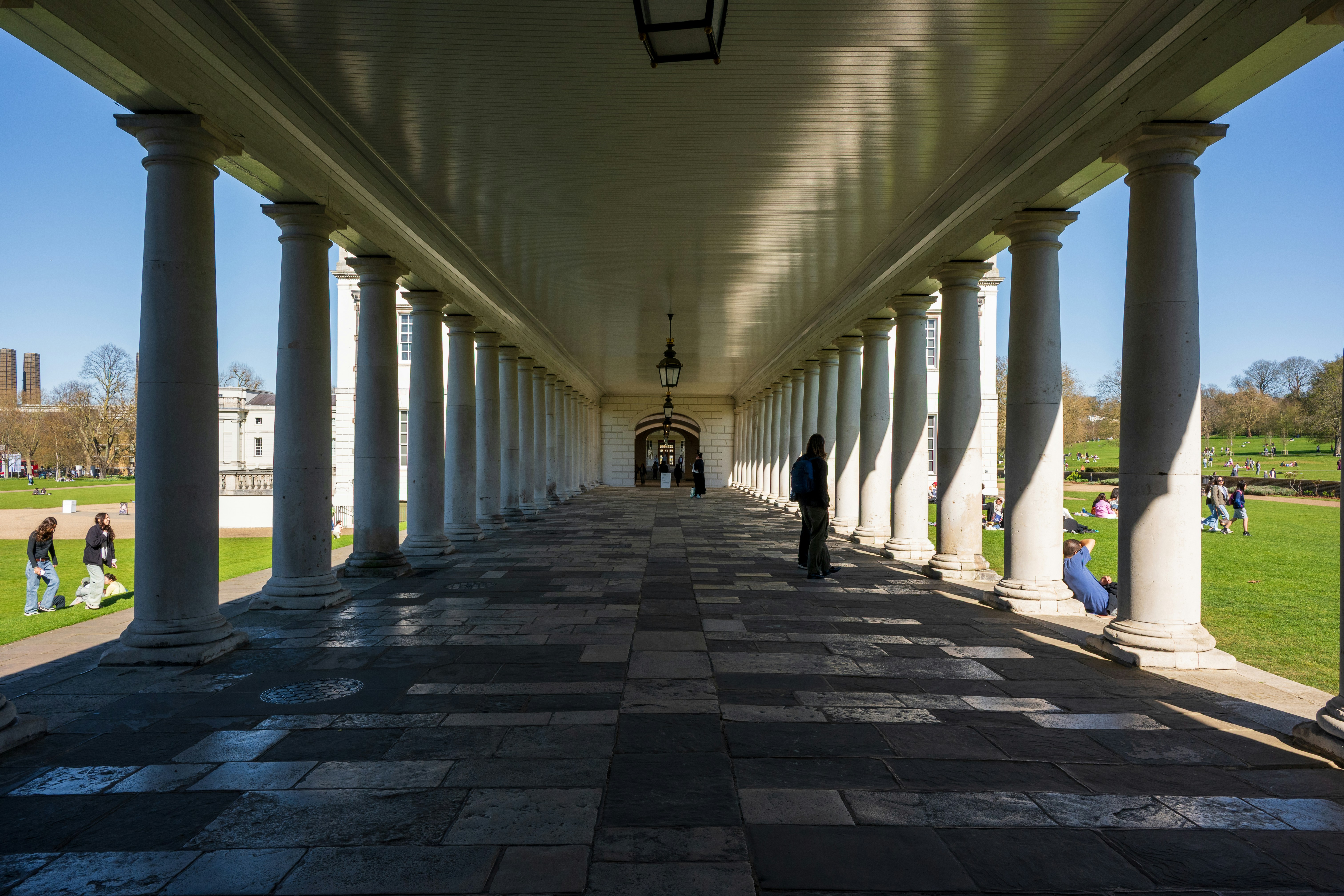 A covered colonnade leads to a distant view. photo – Free Building ...
