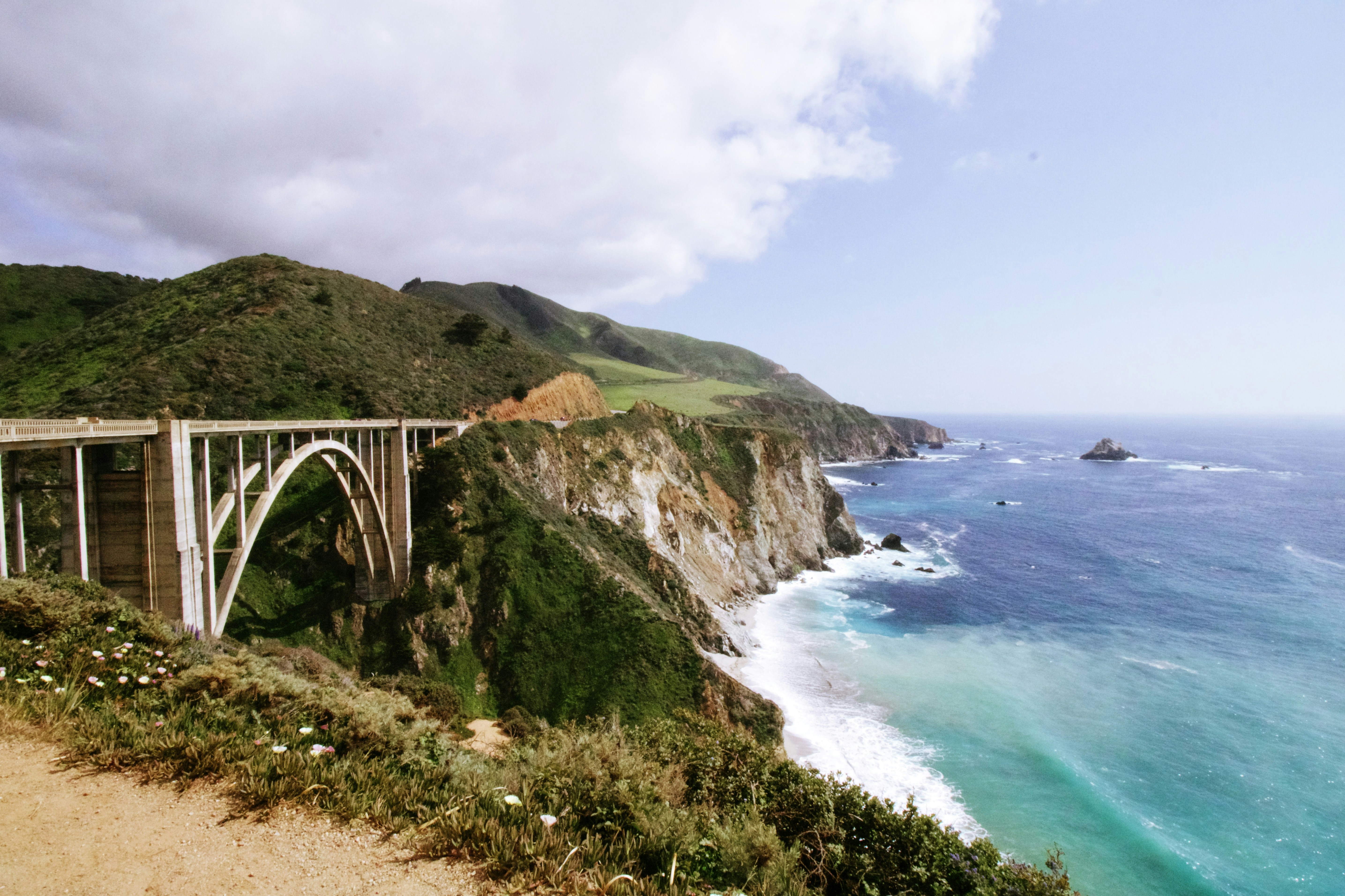 Edge of Light: A Stone-Arch Bridge Fringing the Turquoise Coast