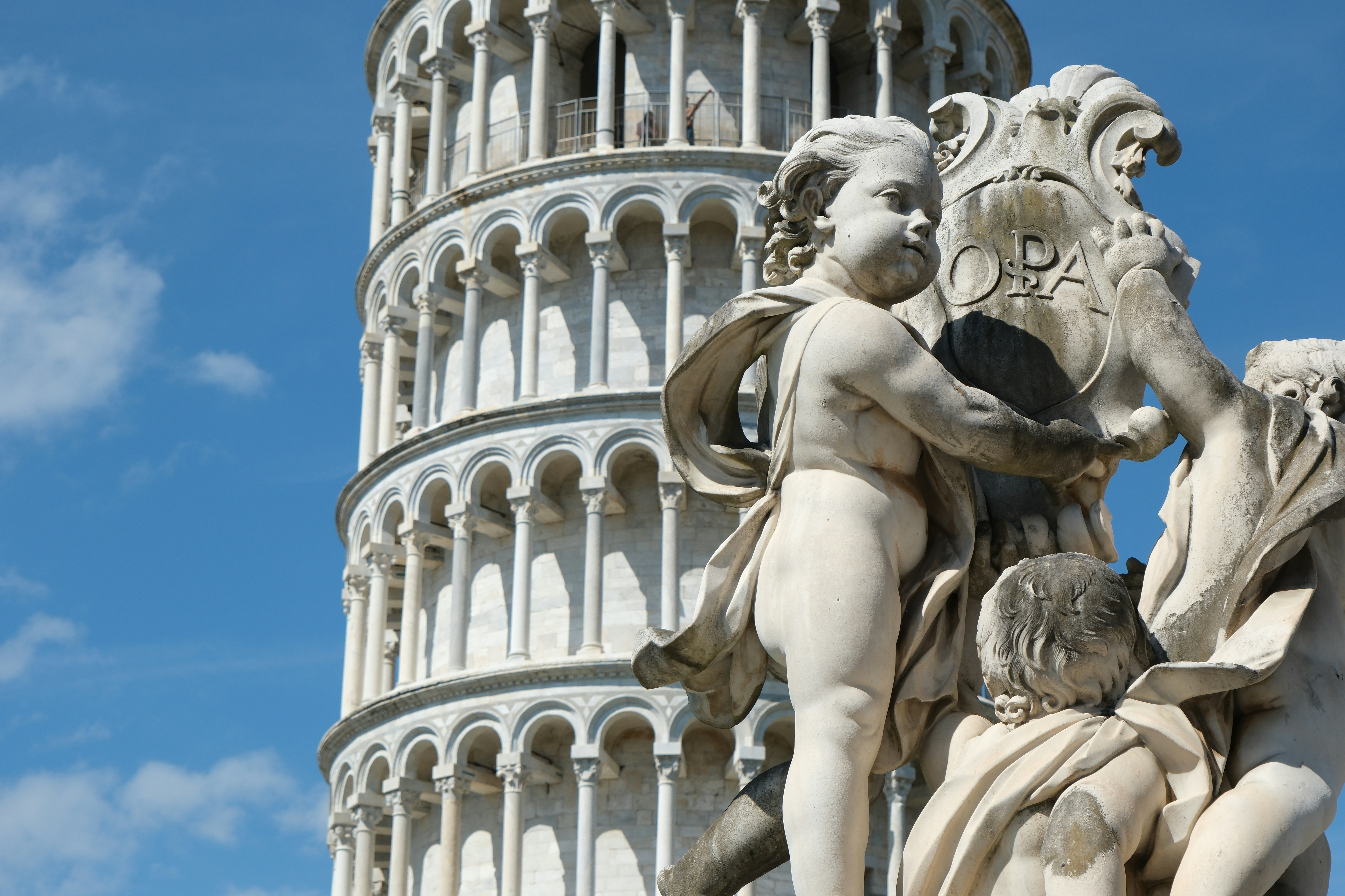 Winged guardians and leaning arches: a sculptural study beside the Leaning Tower
