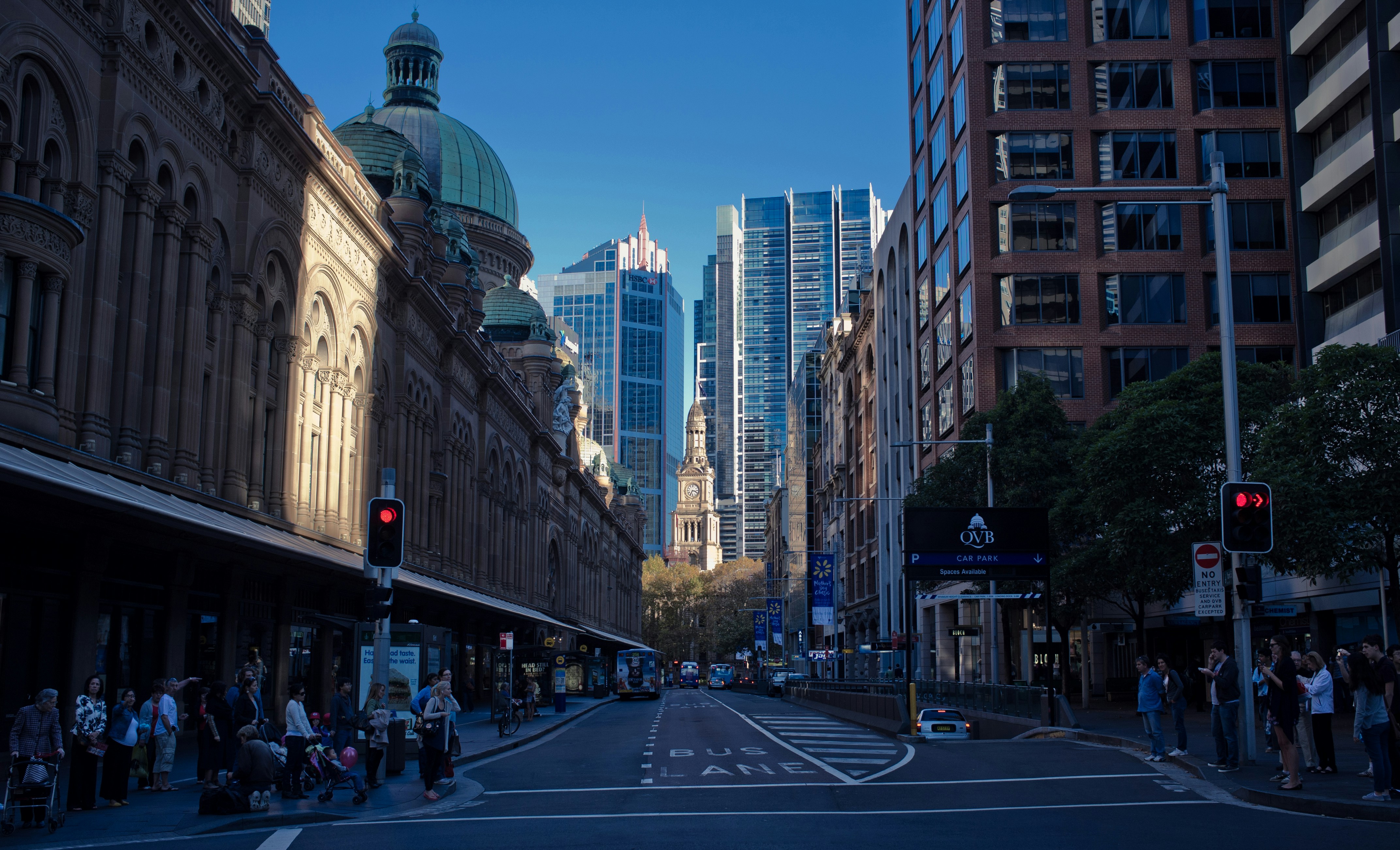 Historic architecture juxtaposed with contemporary skyscrapers in a bustling city street, showcasing the blend of old and new. 