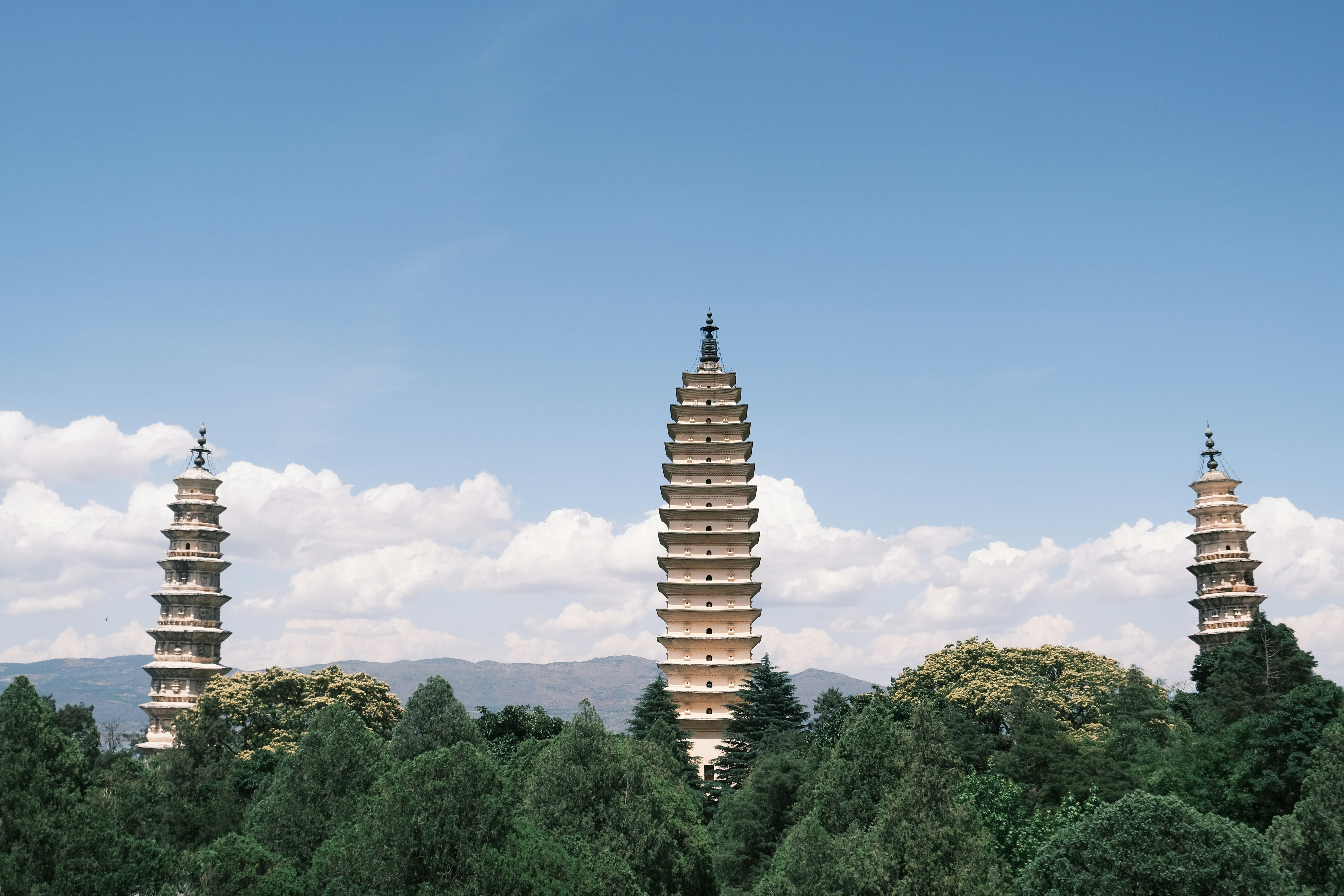 Triadic Pagoda Alignment Against Cloudy Sky