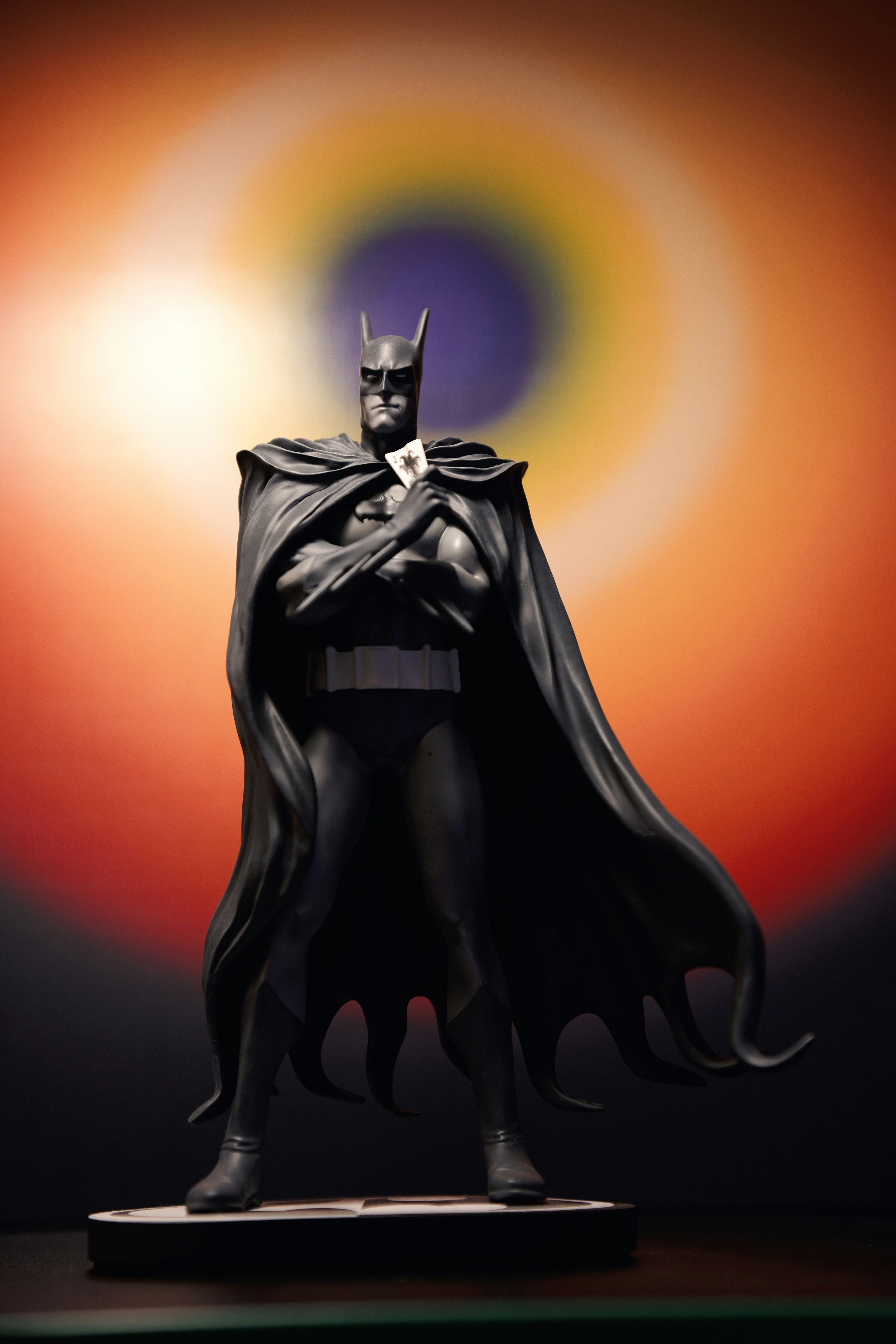 Batman statue stands proudly with arms crossed.