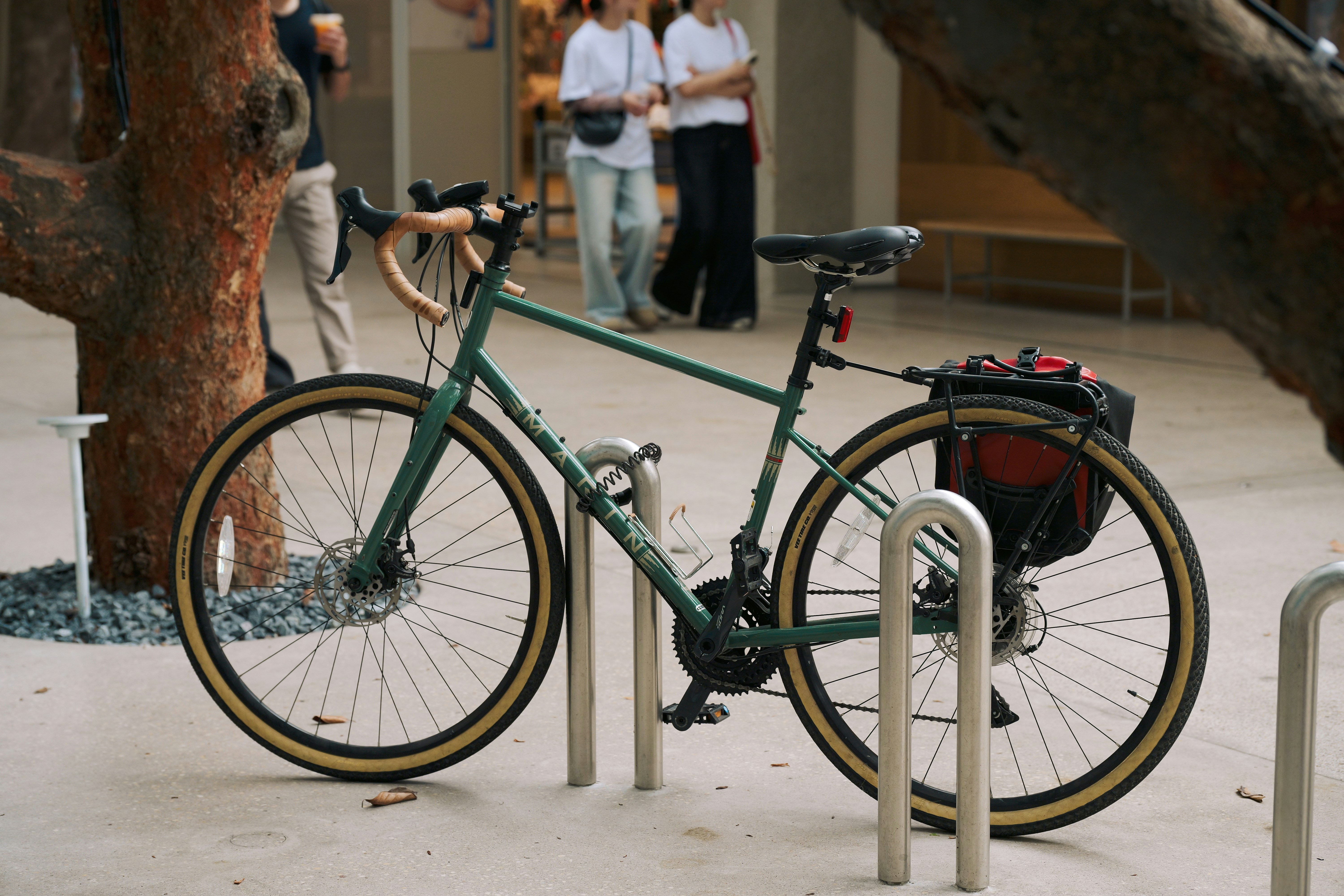 Urban Green: A Commuter Bike Secured by Curved Metal Barriers