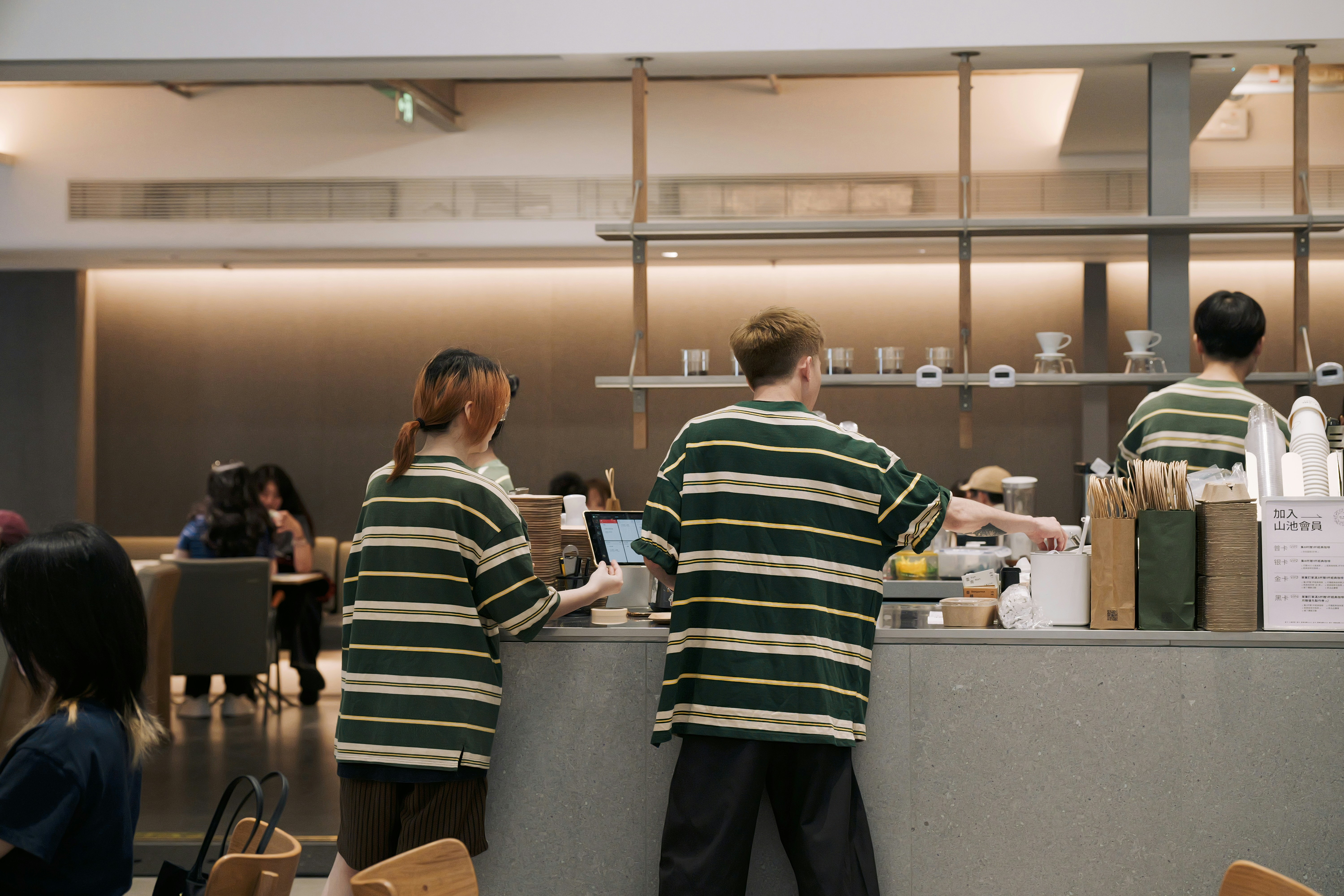 Stripes at the Counter: A Quiet Break Amid the Café Glow
