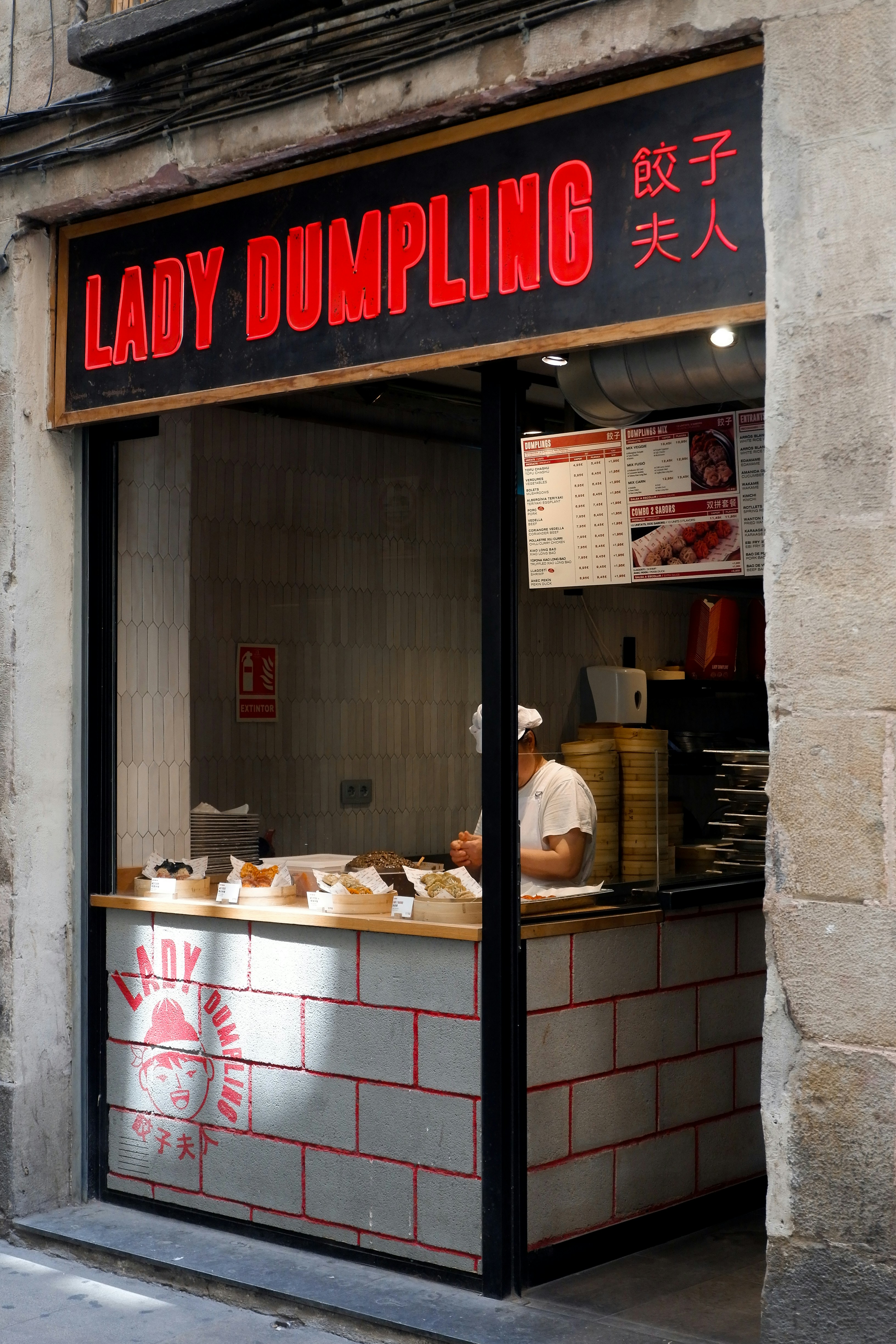 A lady dumpling shop is shown, ready to serve. photo – Free Barcelona ...