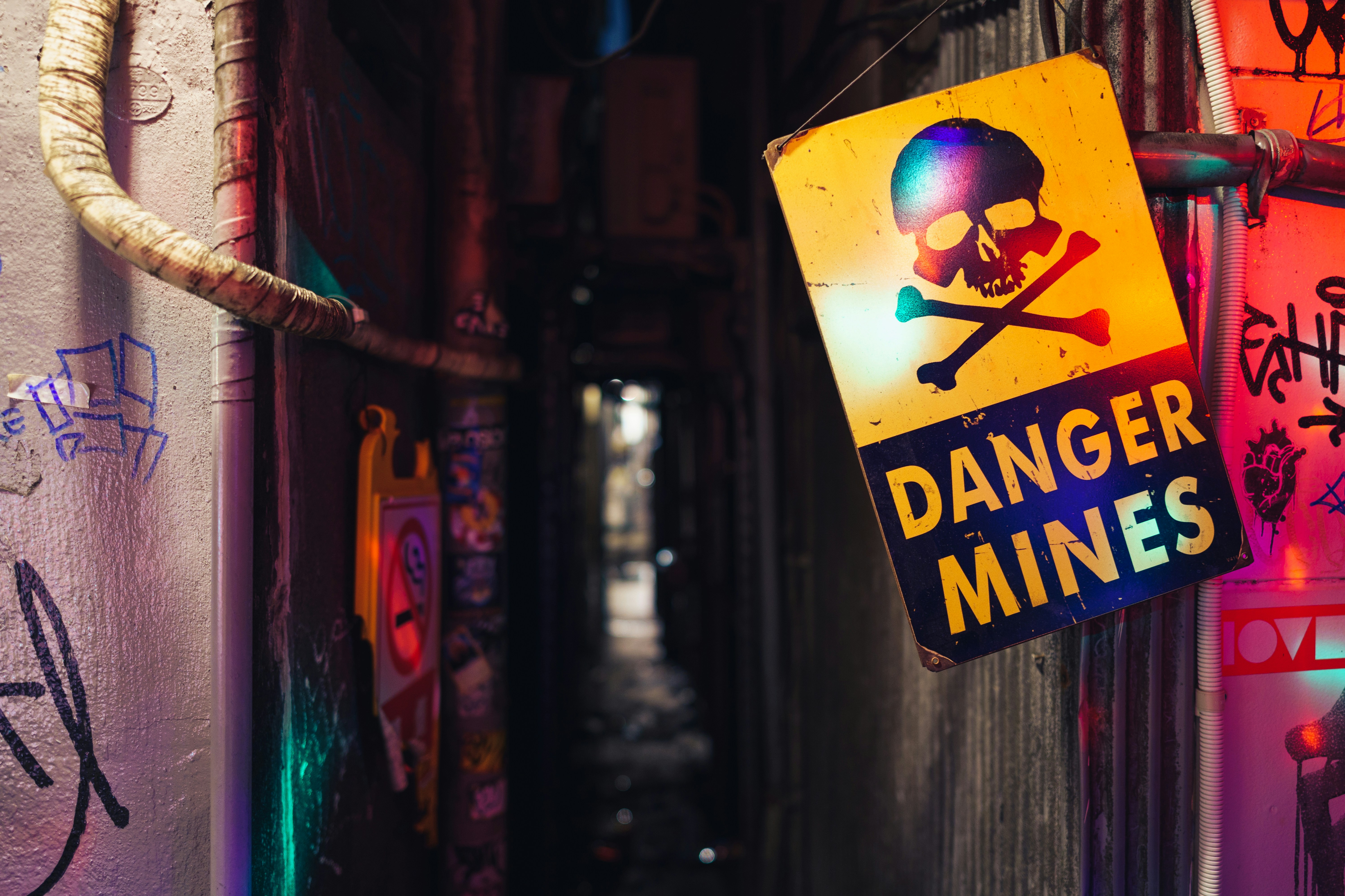 Danger mines sign in a dark alley.