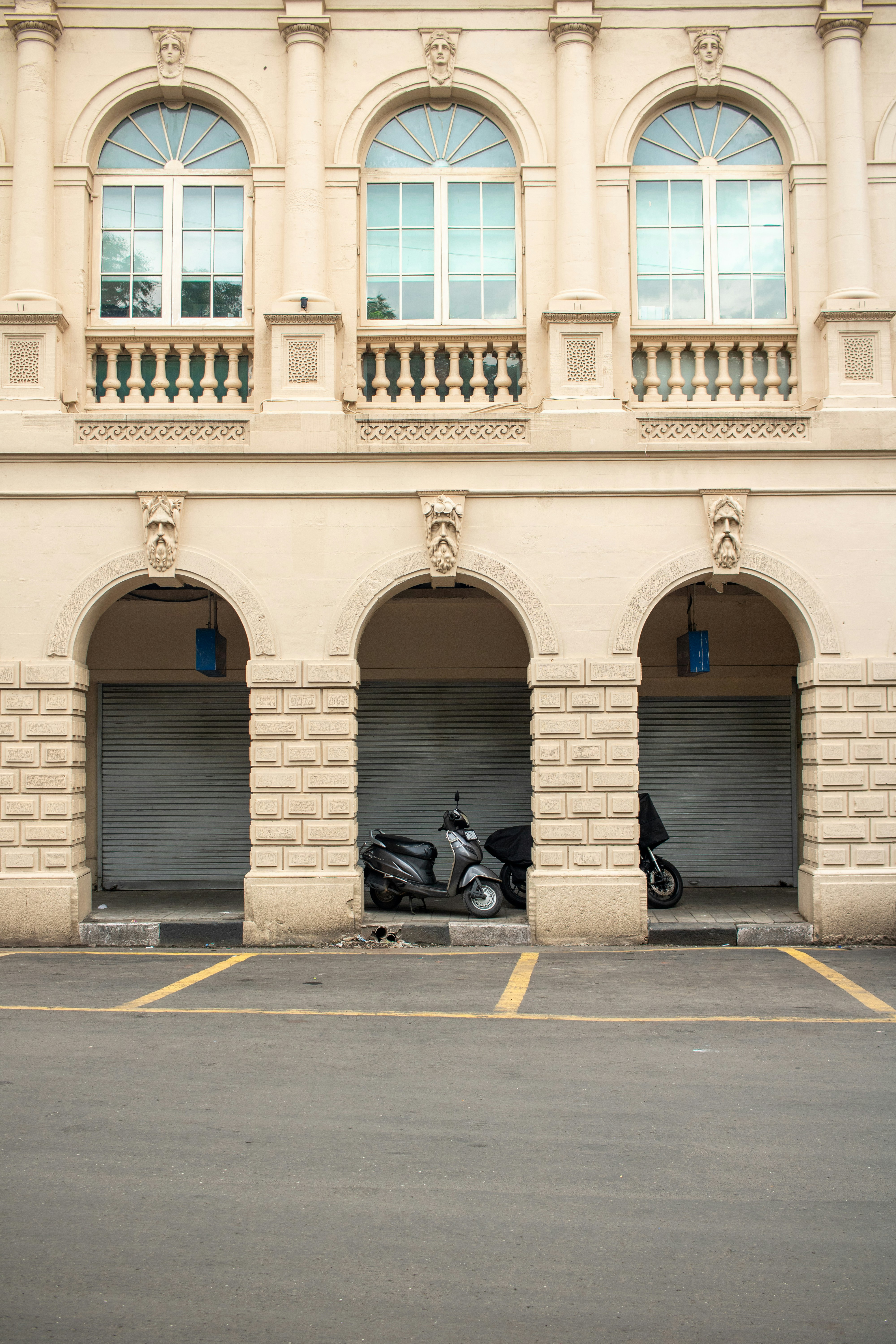 Sunlit Arcades and Idle Scooters: Quiet Texture Along a Historic Façade