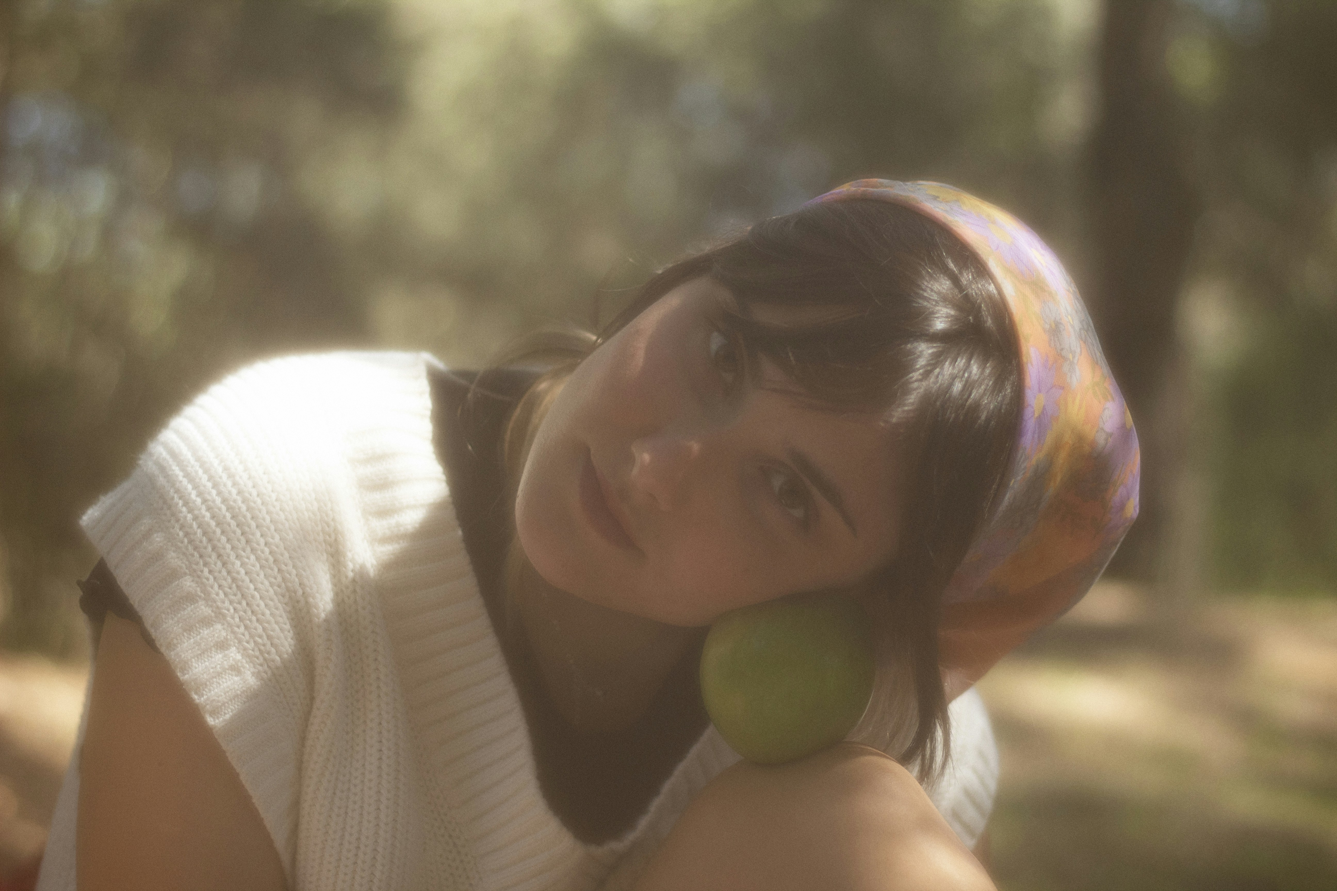 Sunlit Quiet: A Soft Park Portrait with an Apple
