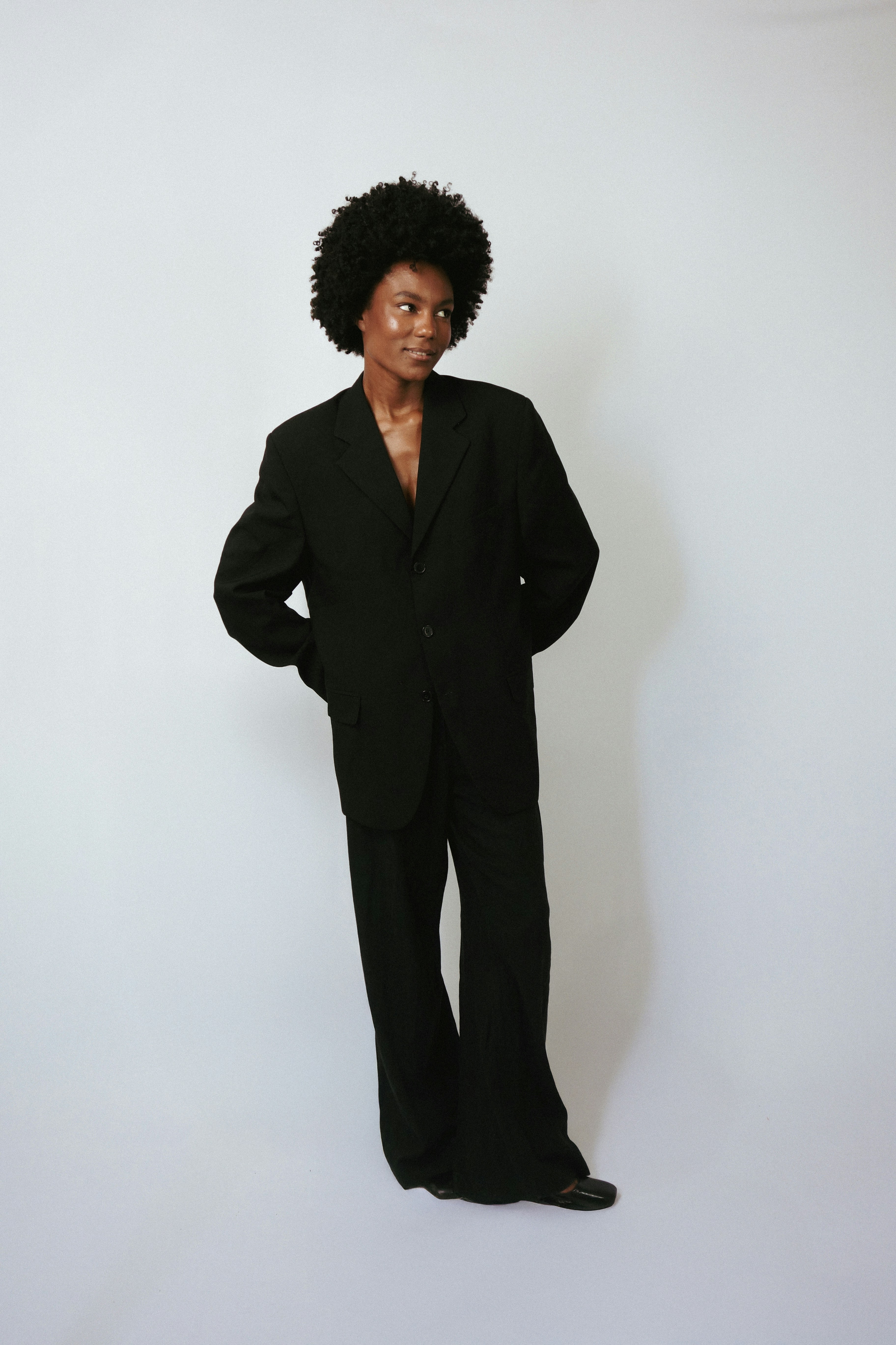 A person models a black suit on a white backdrop. photo – Free Portrait ...