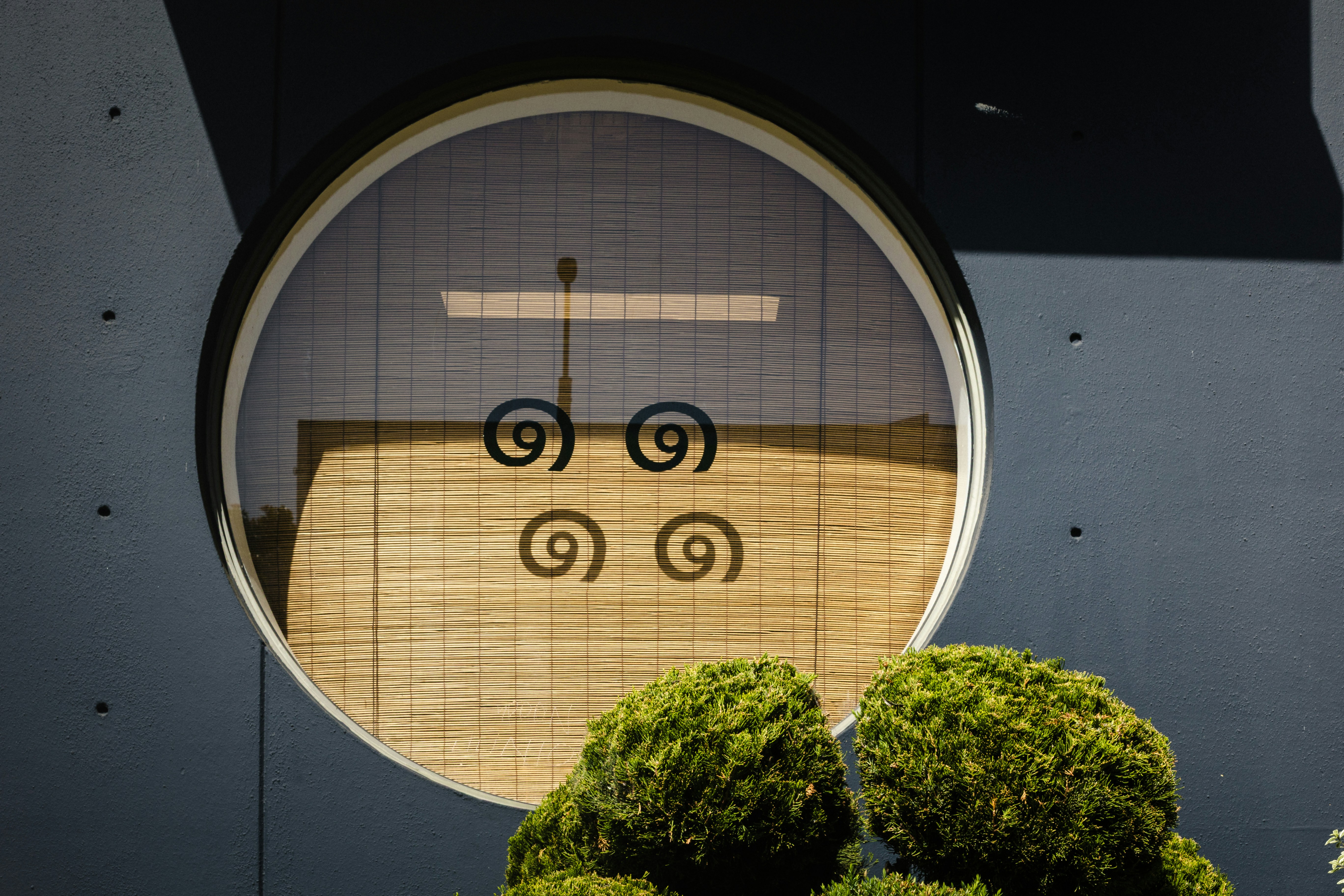 A round window with bamboo and spiraling designs. photo – Free Building ...