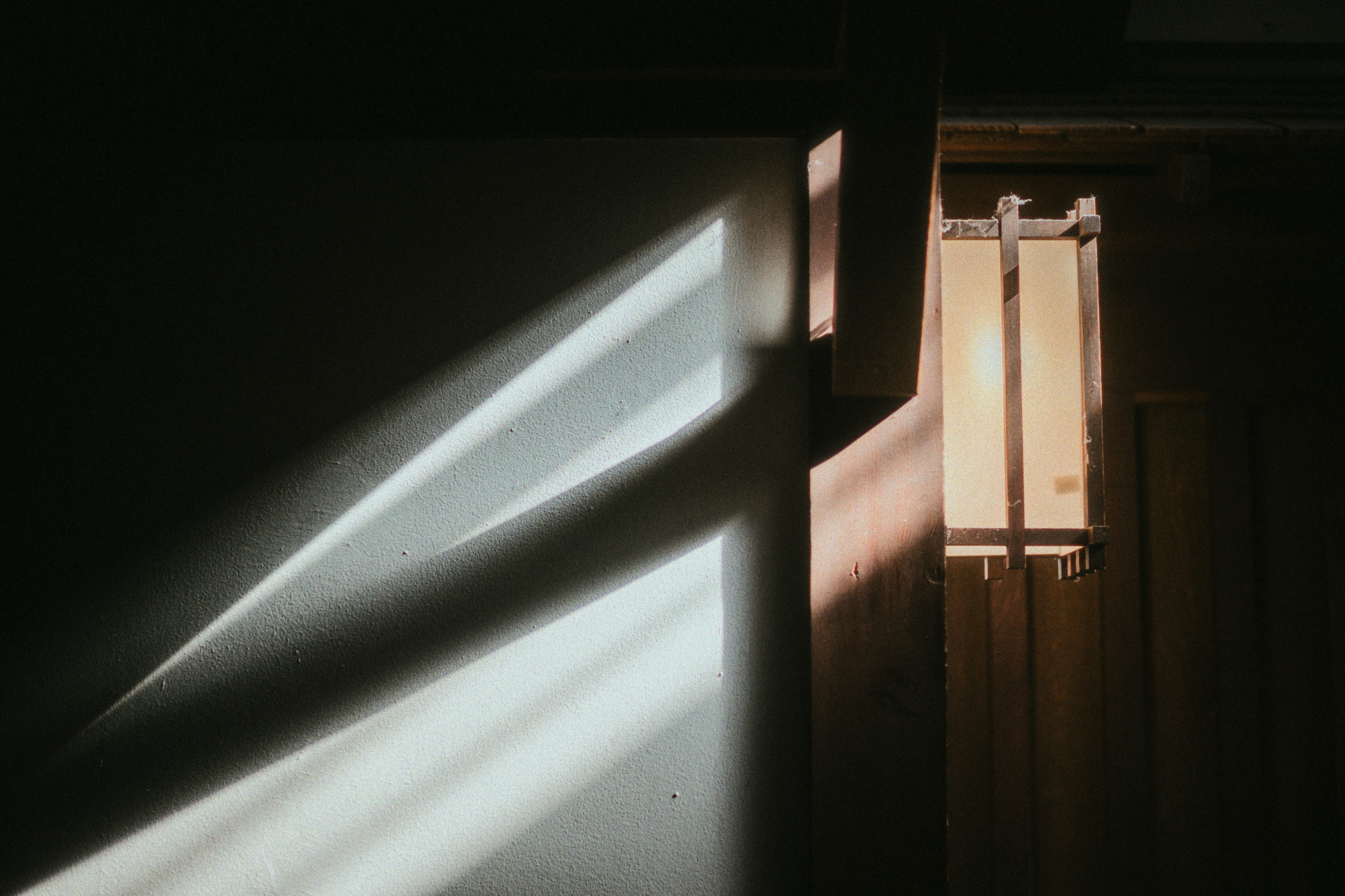 Sunlight streams through a window onto a wall.