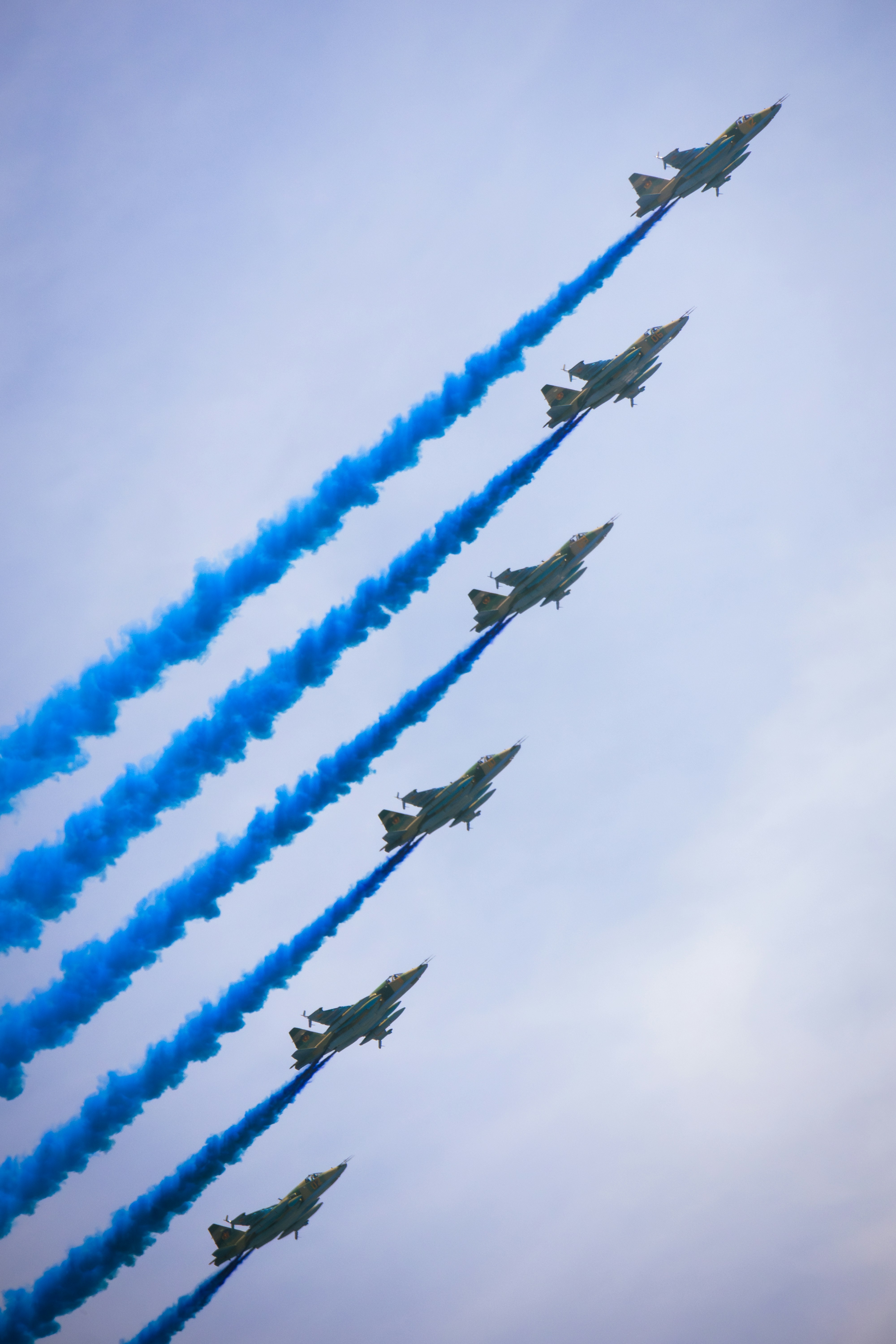 Cobalt Arcs: Six-Jet Formation Traces Blue Trails Across the Sky