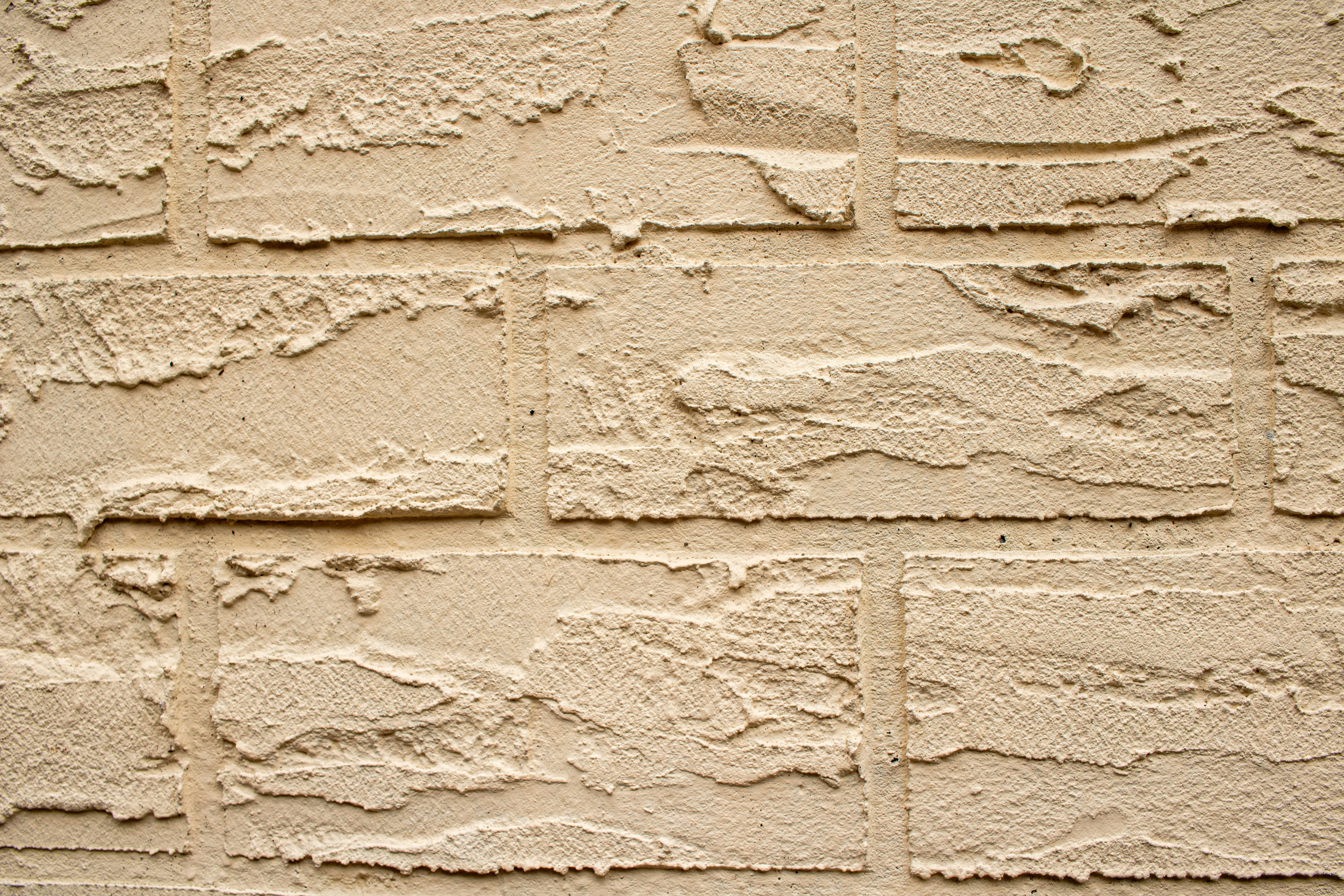 Close-up of a textured beige wall showcasing intricate patterns and depth. This illustration highlights the craftsmanship of wall finishes.