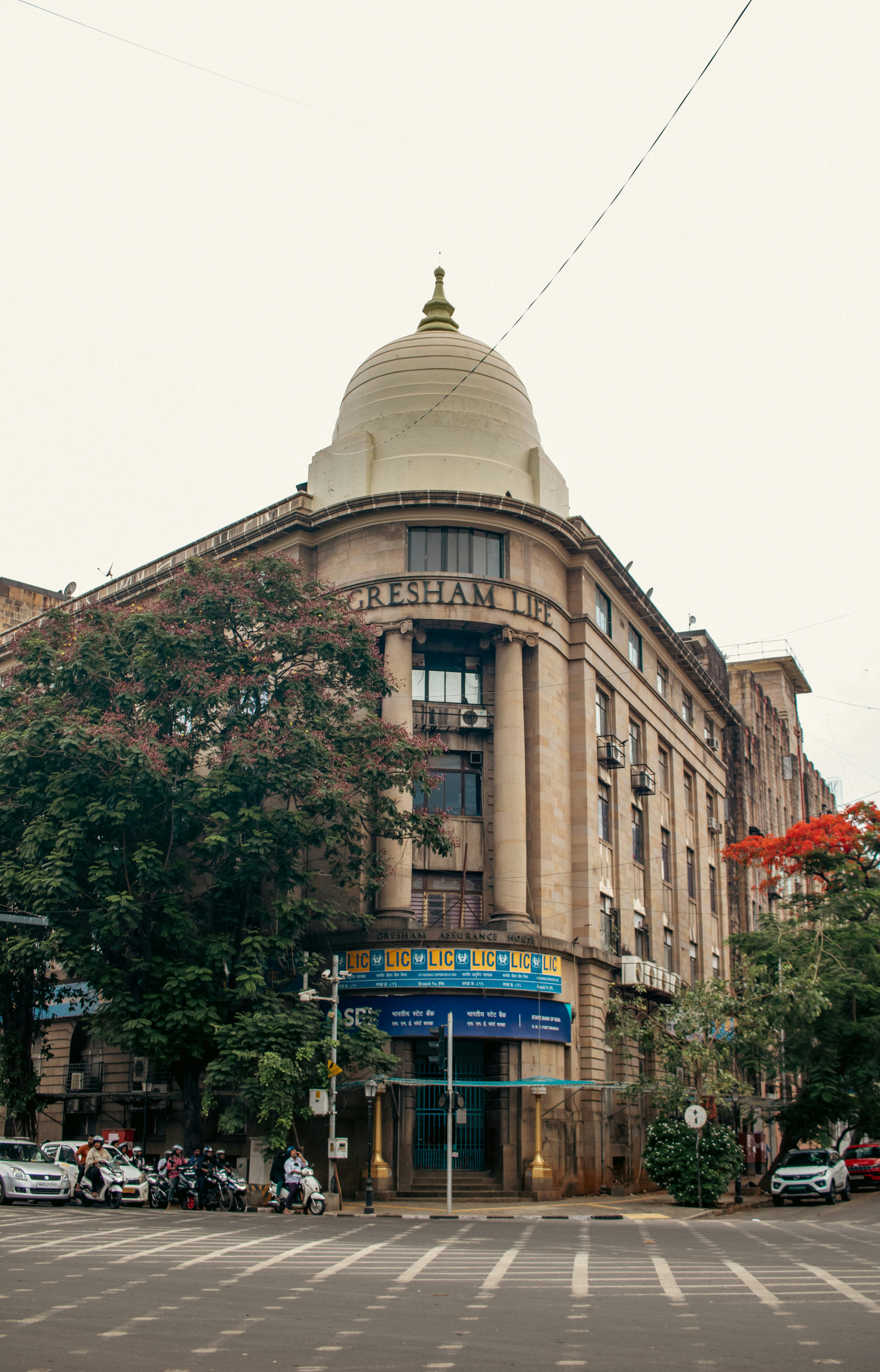 Gresham Assurance House is a heritage building in the heart of Fort, South Mumbai. Built during the British colonial era, it showcases a stunning blend of Gothic and Victorian architectural elements—arched windows, stone masonry, and ornate details that reflect Mumbai’s rich colonial past. Once home to the Gresham Life Assurance Society, the building now stands as a reminder of the city’s financial and architectural legacy. Nestled among other iconic structures, it’s a key visual and cultural anchor in Mumbai’s historic business district.
