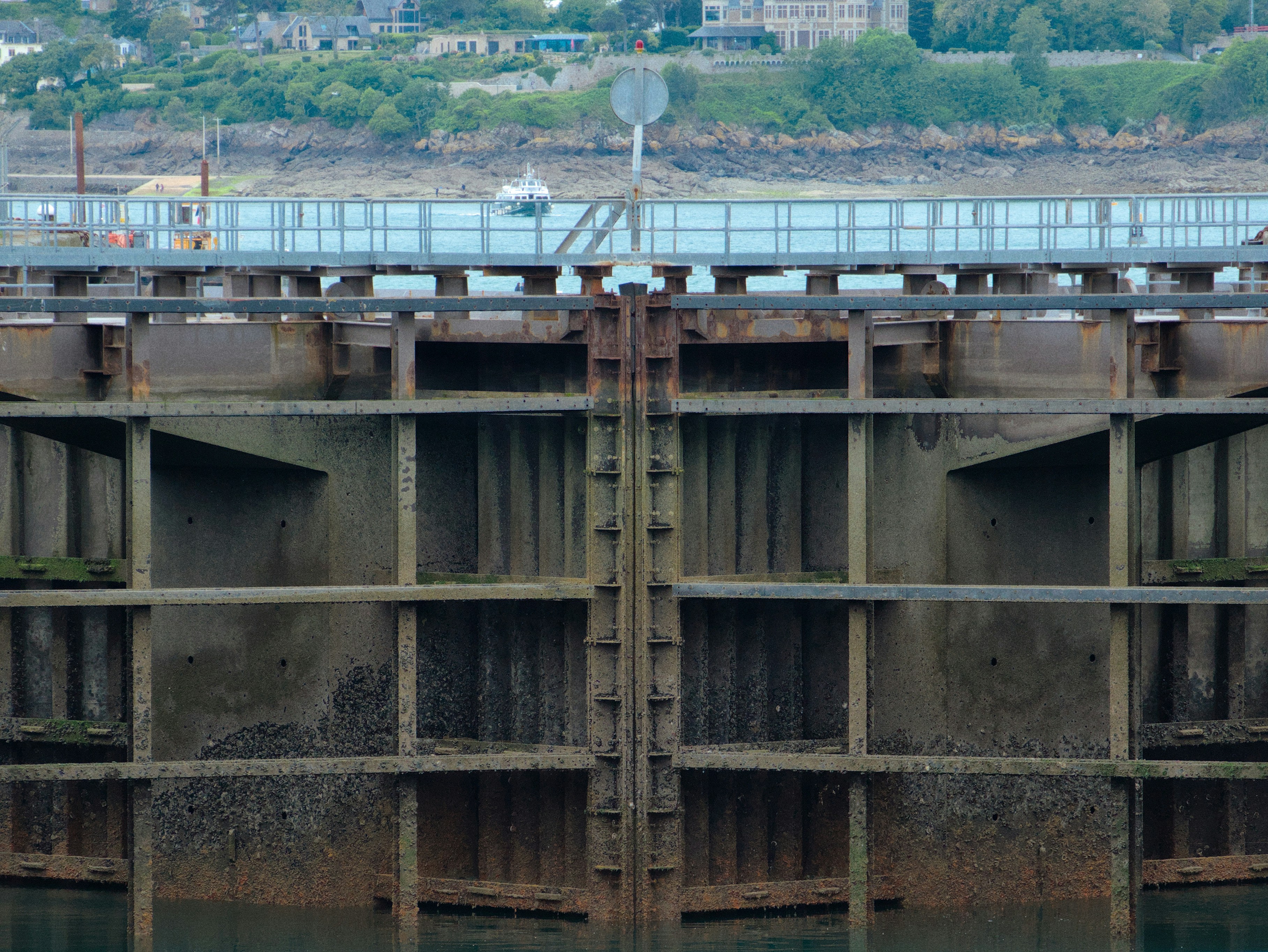 Convergence of Rust: a central pier grid framing a distant harbor