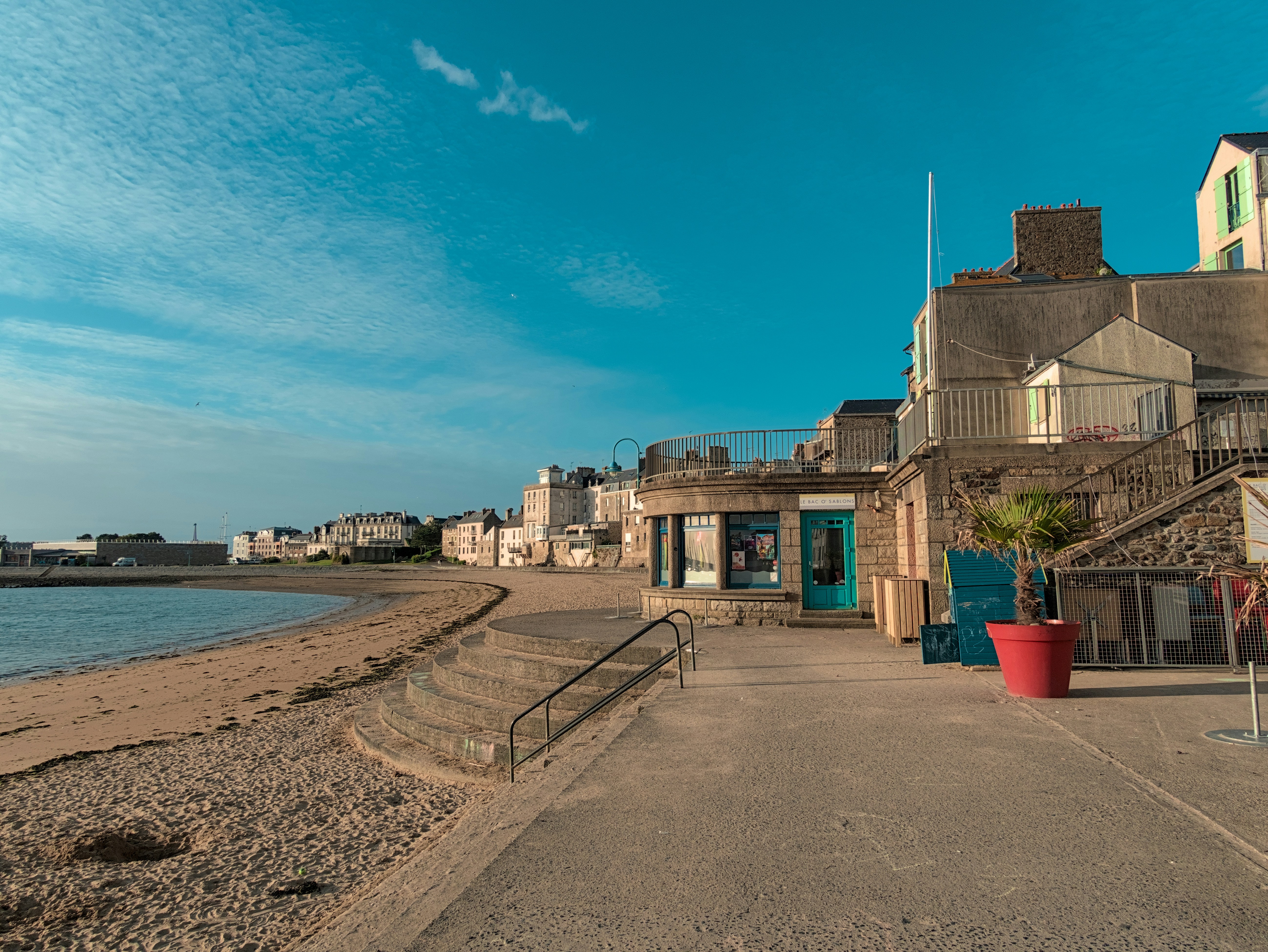 A seaside path next to a beach and buildings. photo – Free Food Image ...