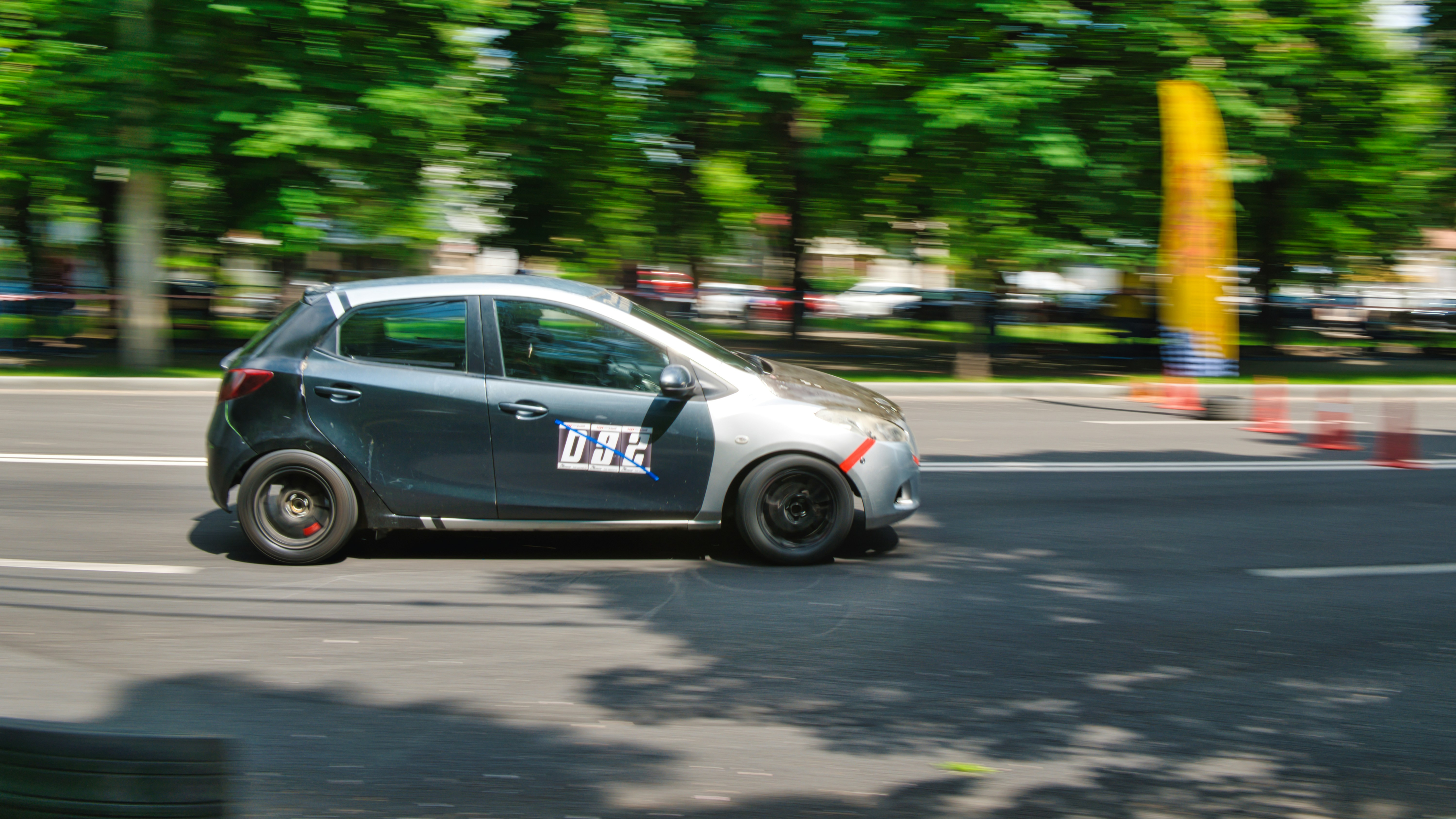 Blue hatchback in motion: drifting through the city course
