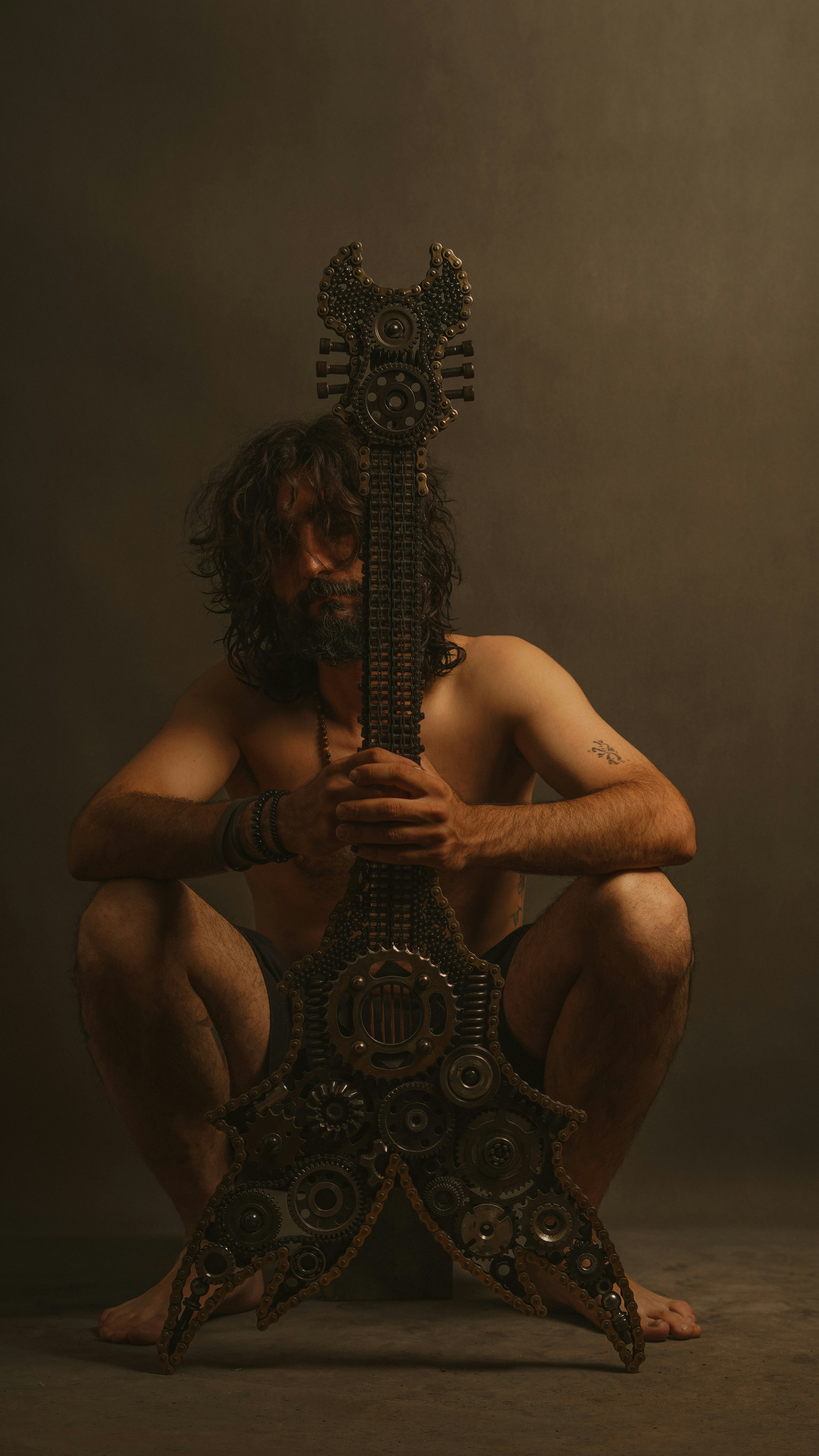 Gears of Gravity: A Steampunk Key Embraced by a Bare-Chested Silhouette