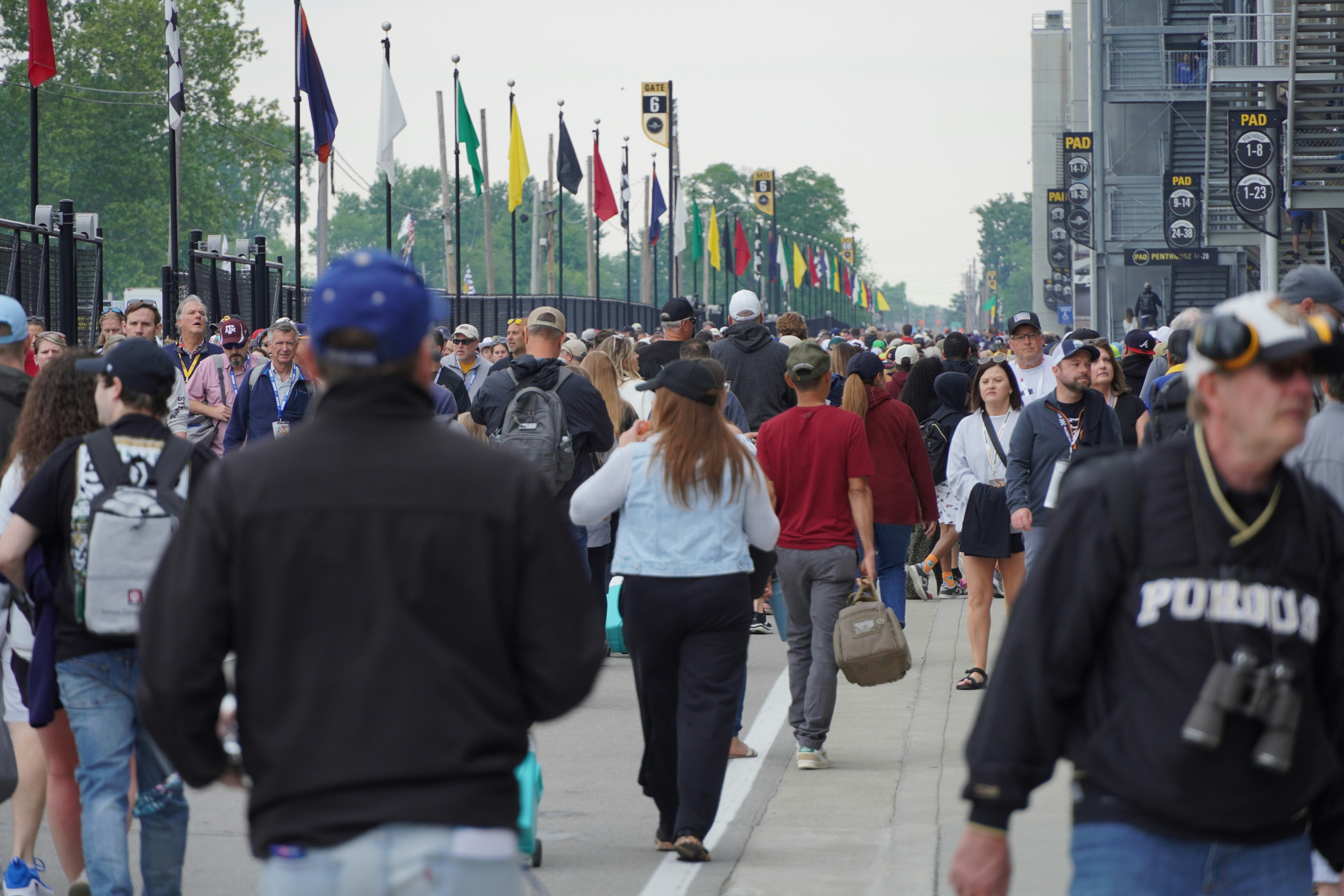 People walk down a crowded street with flags. photo – Free People Image ...