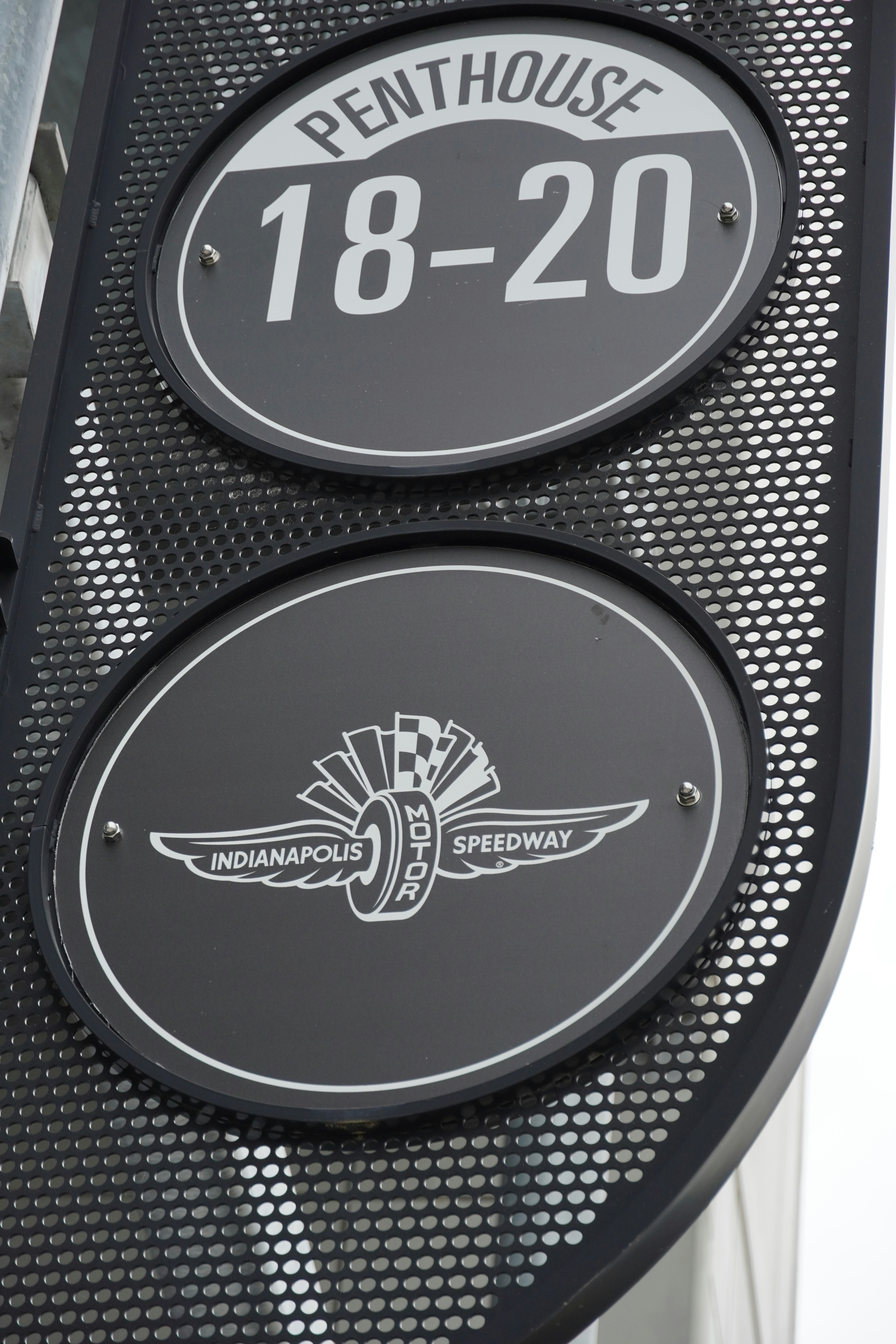 Penthouse 18-20 Signage Meets Indy Speedway Emblem on Perforated Metal