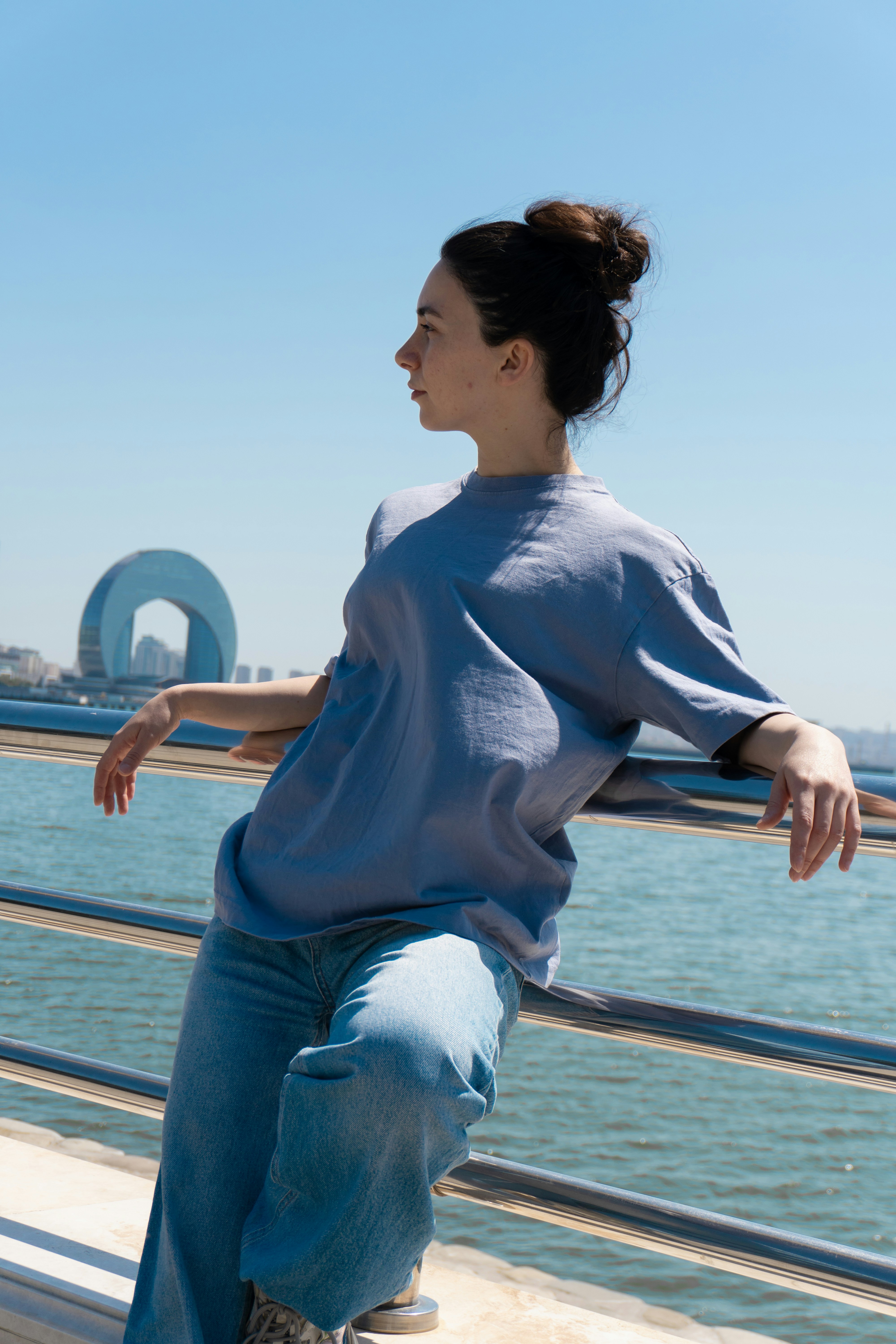 A woman poses outdoors leaning against a railing. photo – Free Portrait ...