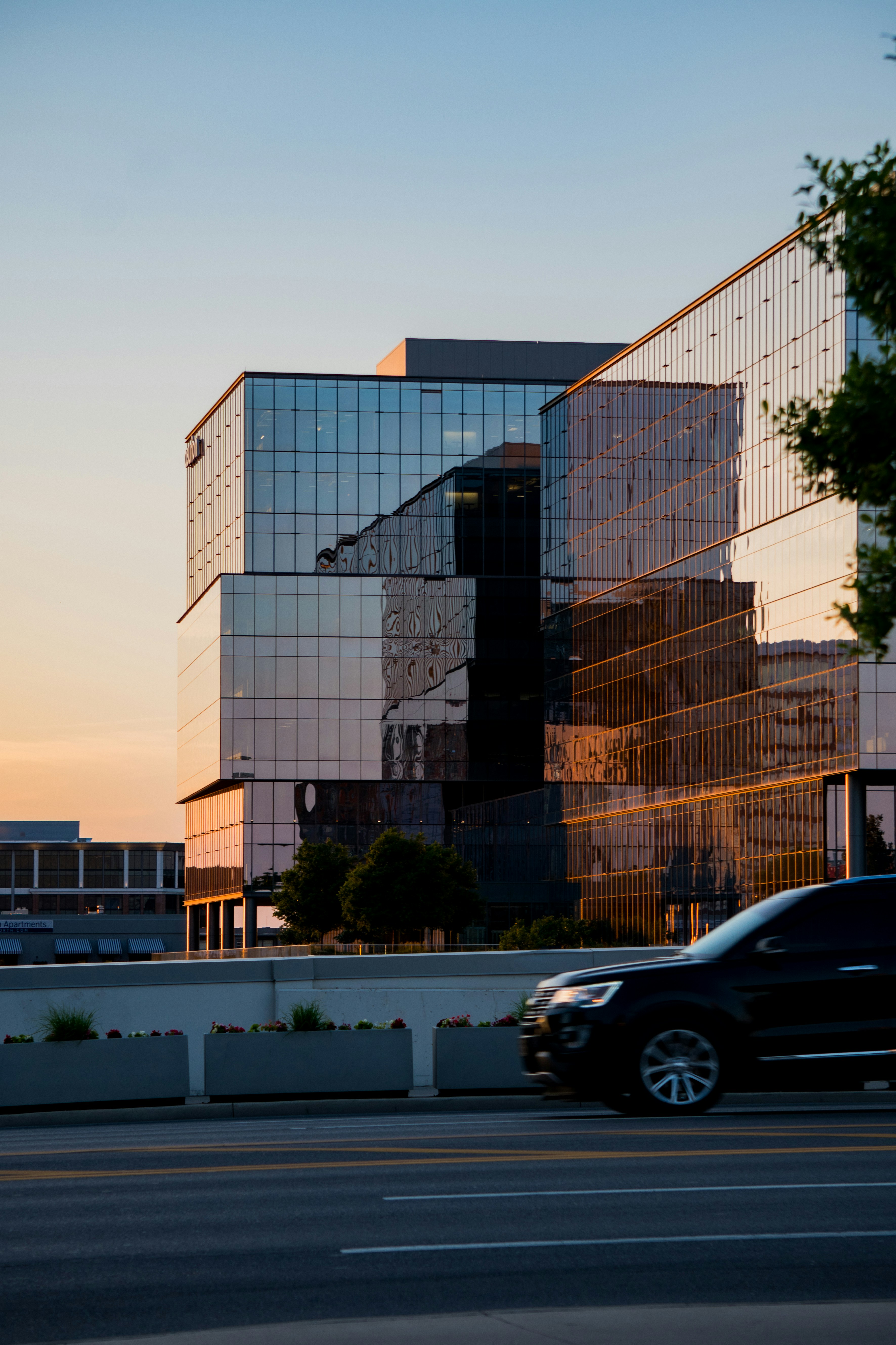 Glass Facade Echoes of Sunset Over the City Highway