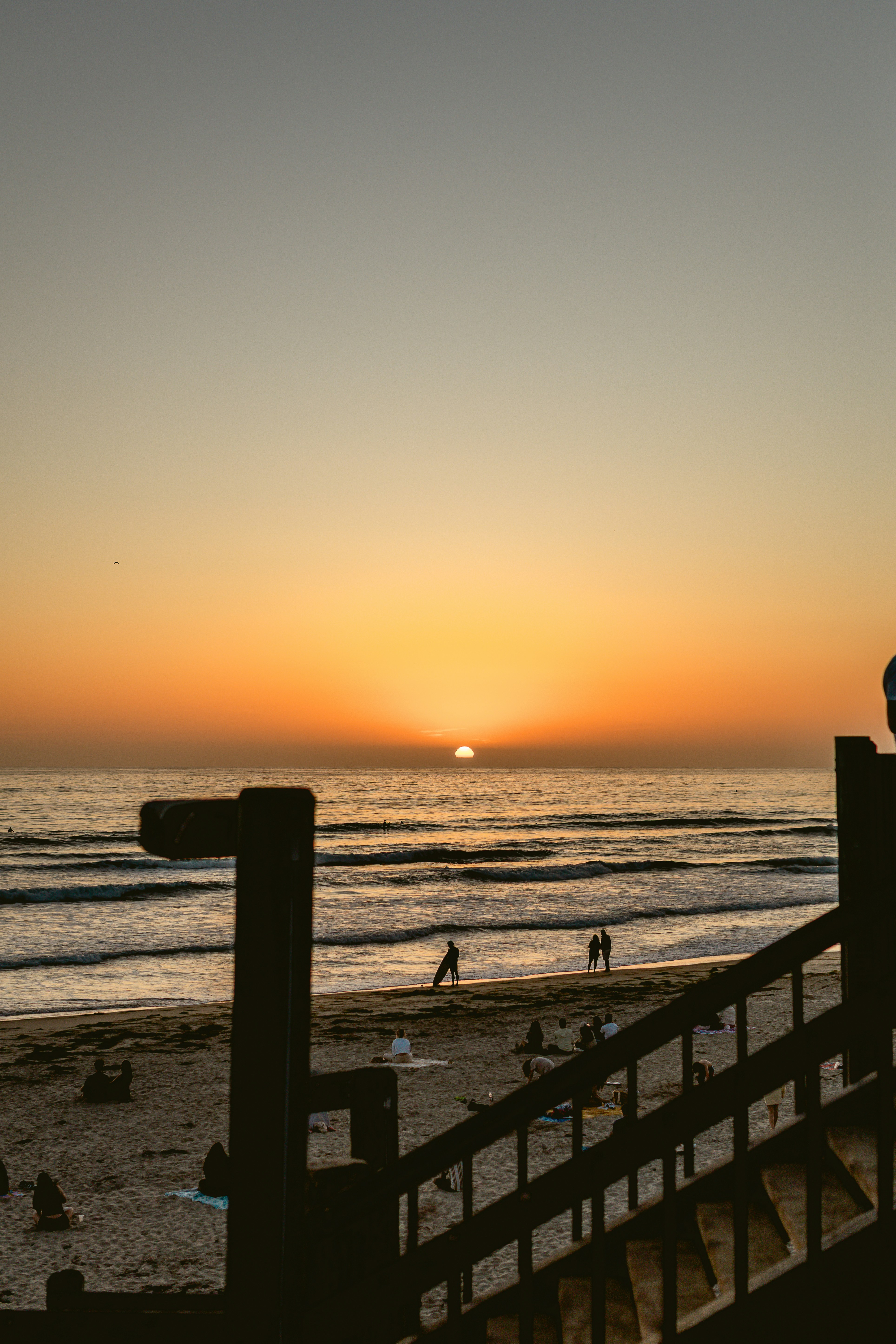 Sunset Geometry: Railings Framing a Quiet Beach Horizon