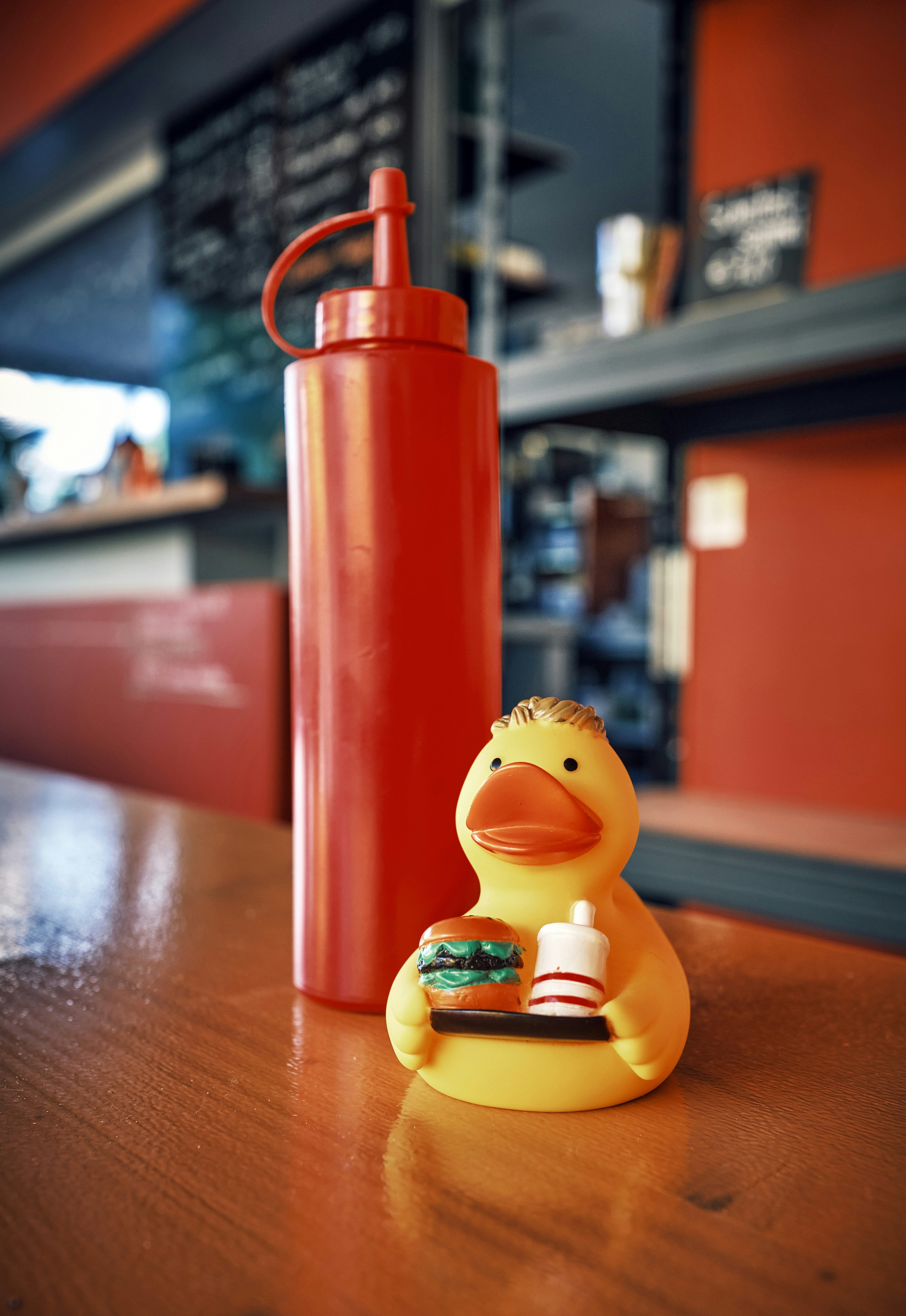 Tiny Duck, Big Snack: A Café Moment with Burger and Milkshake