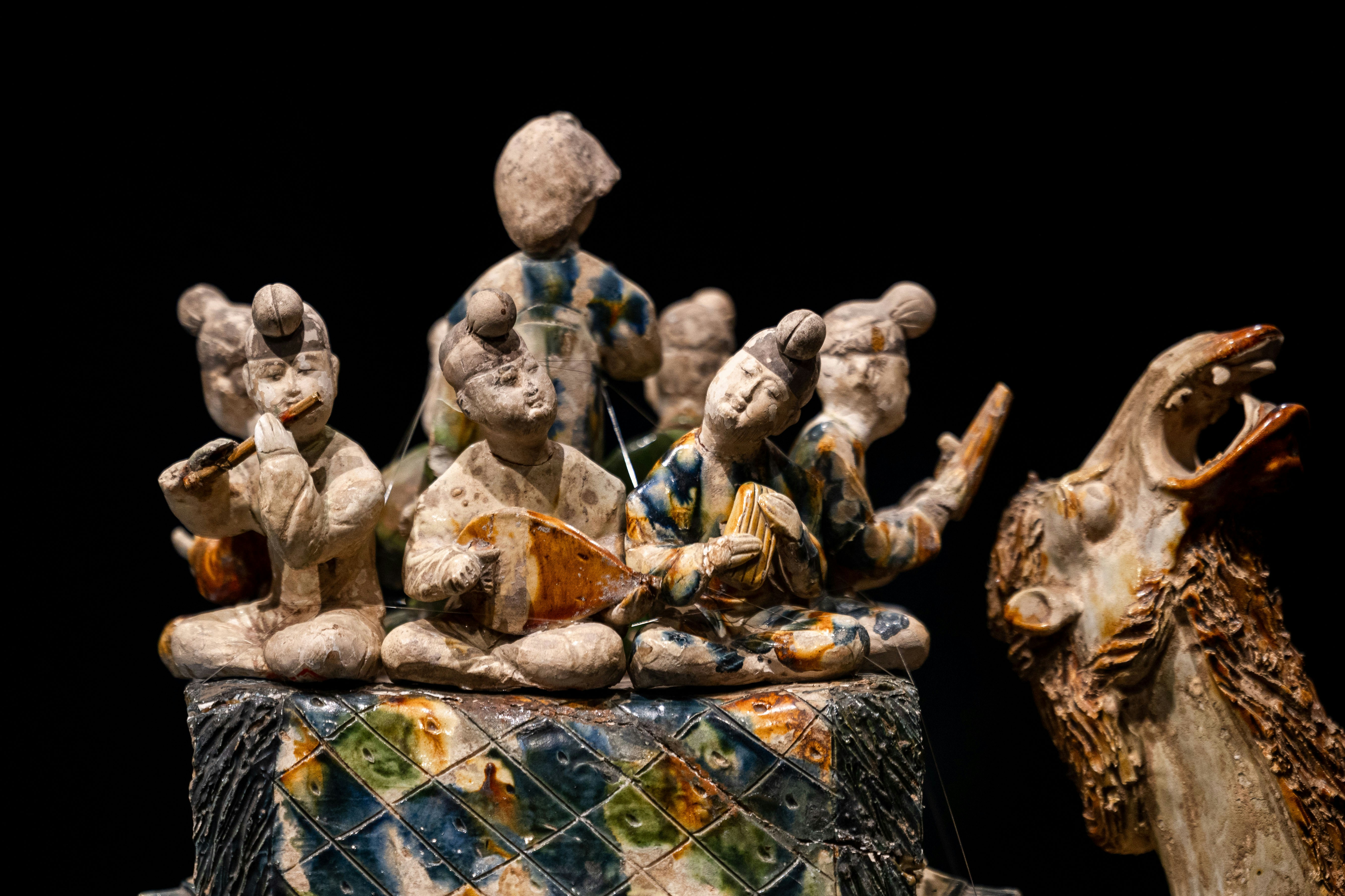 Ceramic Chorus: Minstrel Figures Ring a Tile-Glazed Pedestal